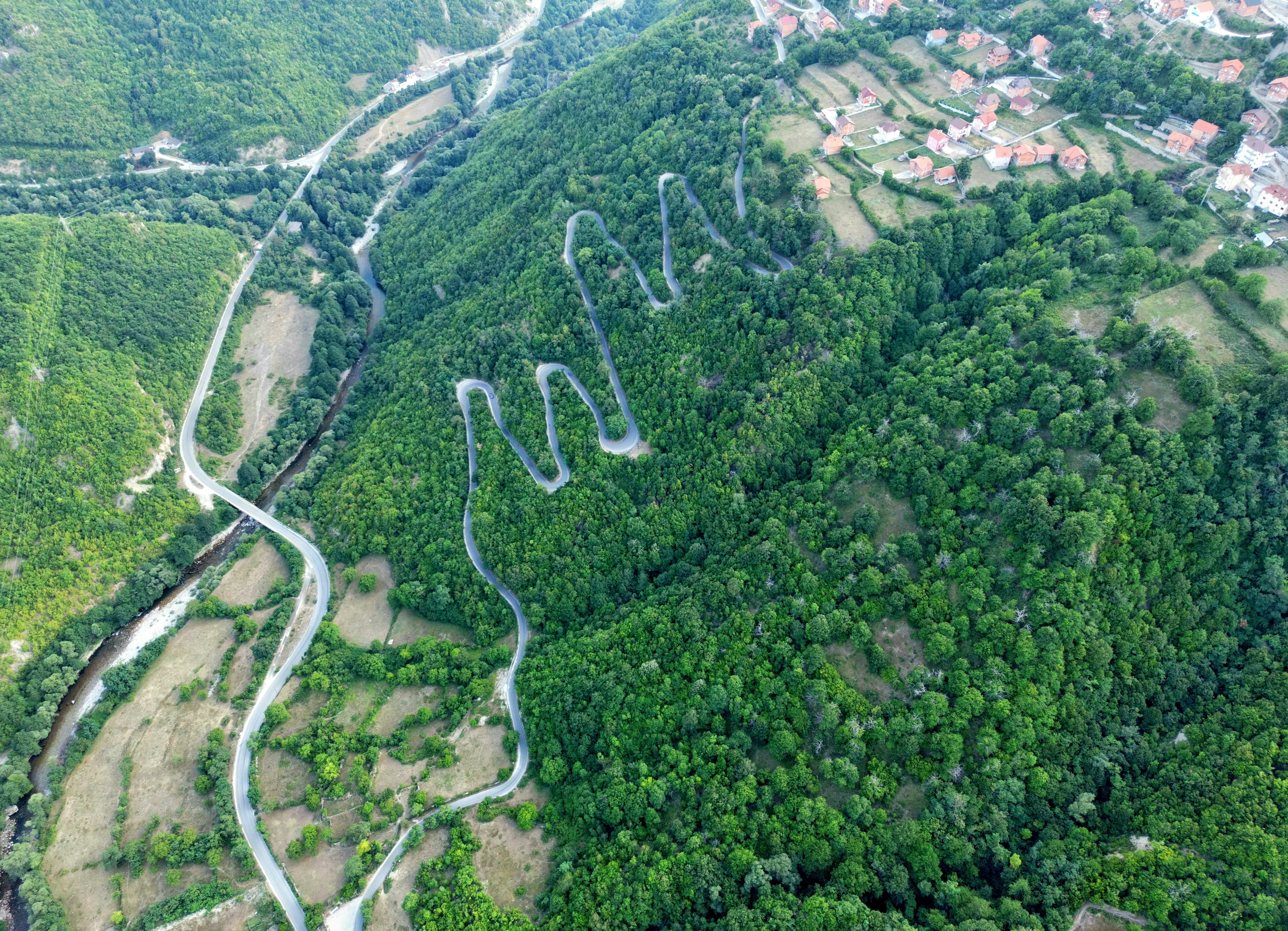 Serpentine Road Slice Through a Lush Green Valley