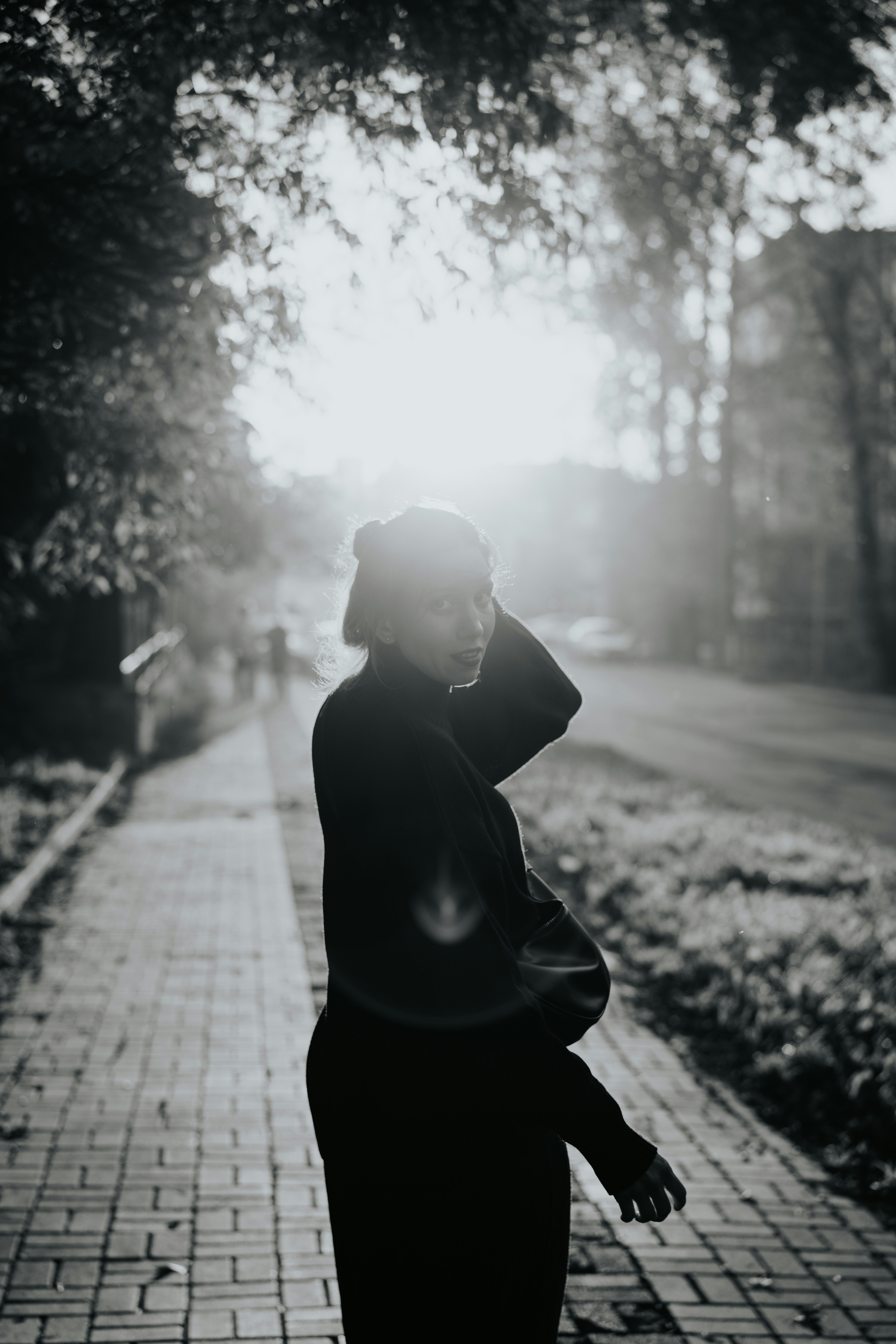 Backlit silhouette on a sunlit boulevard