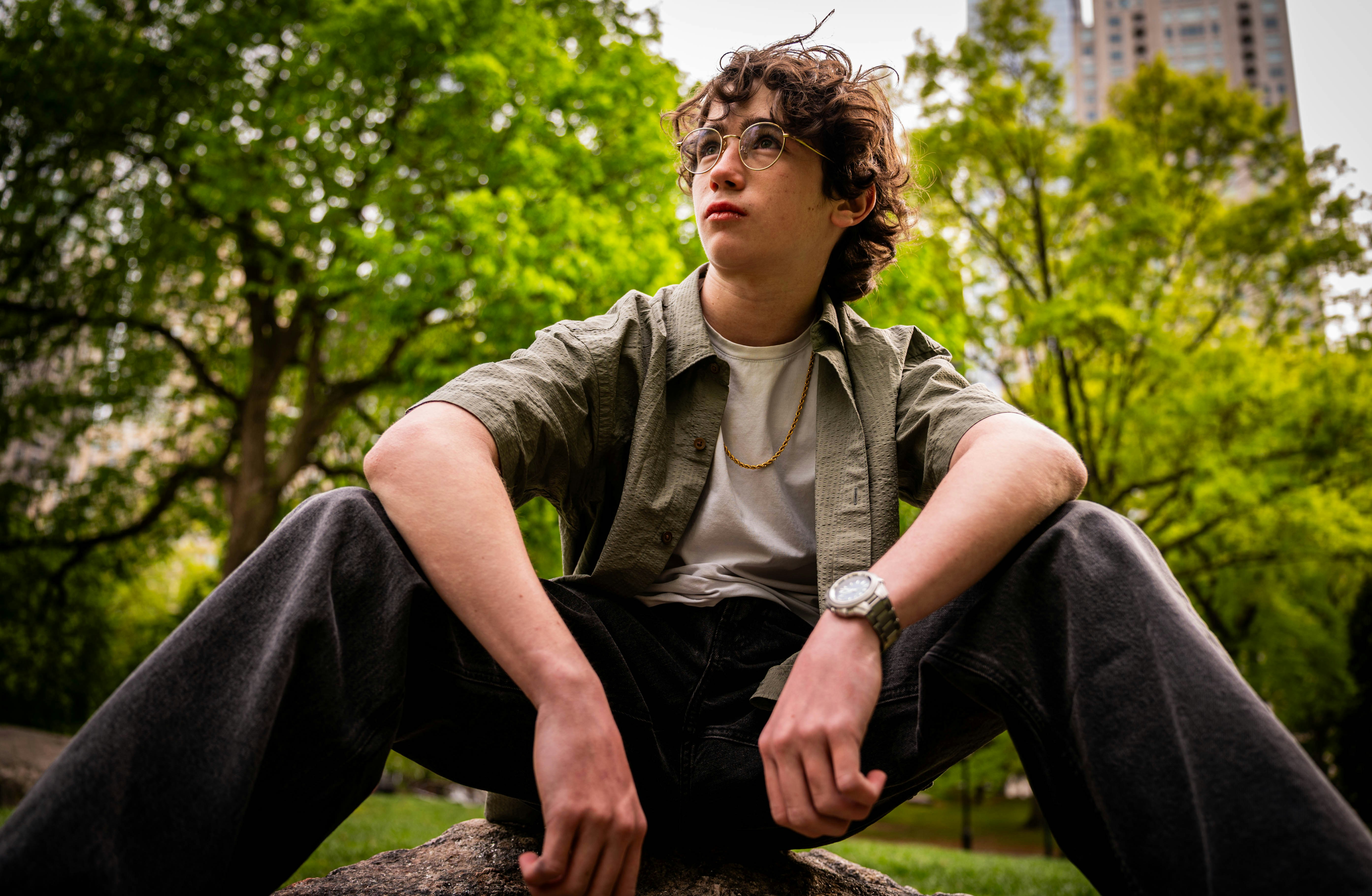 Casual Youth in a Park: Quiet Confidence Under Green Canopy