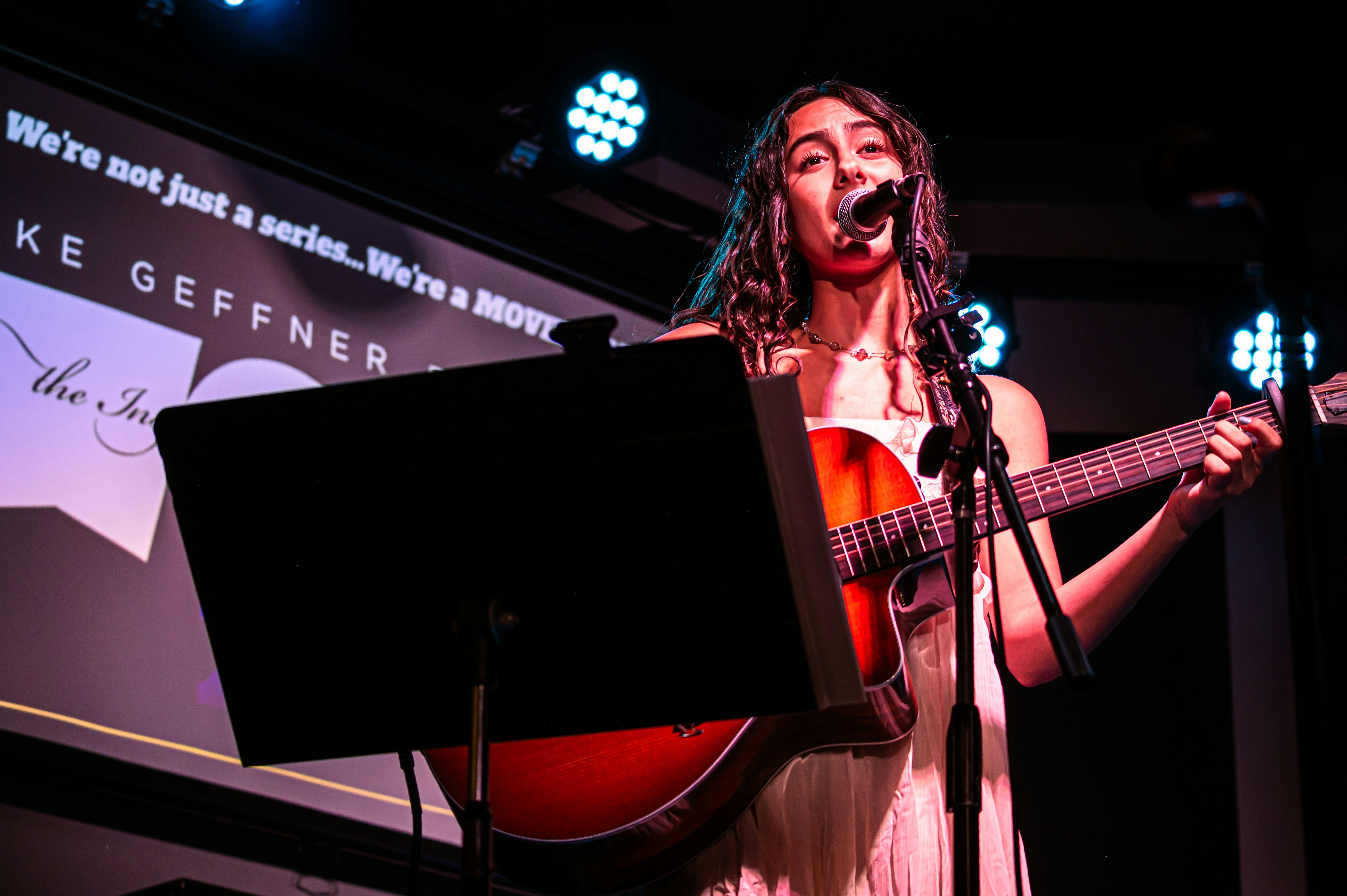Midnight Serenade: Acoustic Guitar, Spotlight, and Microphone