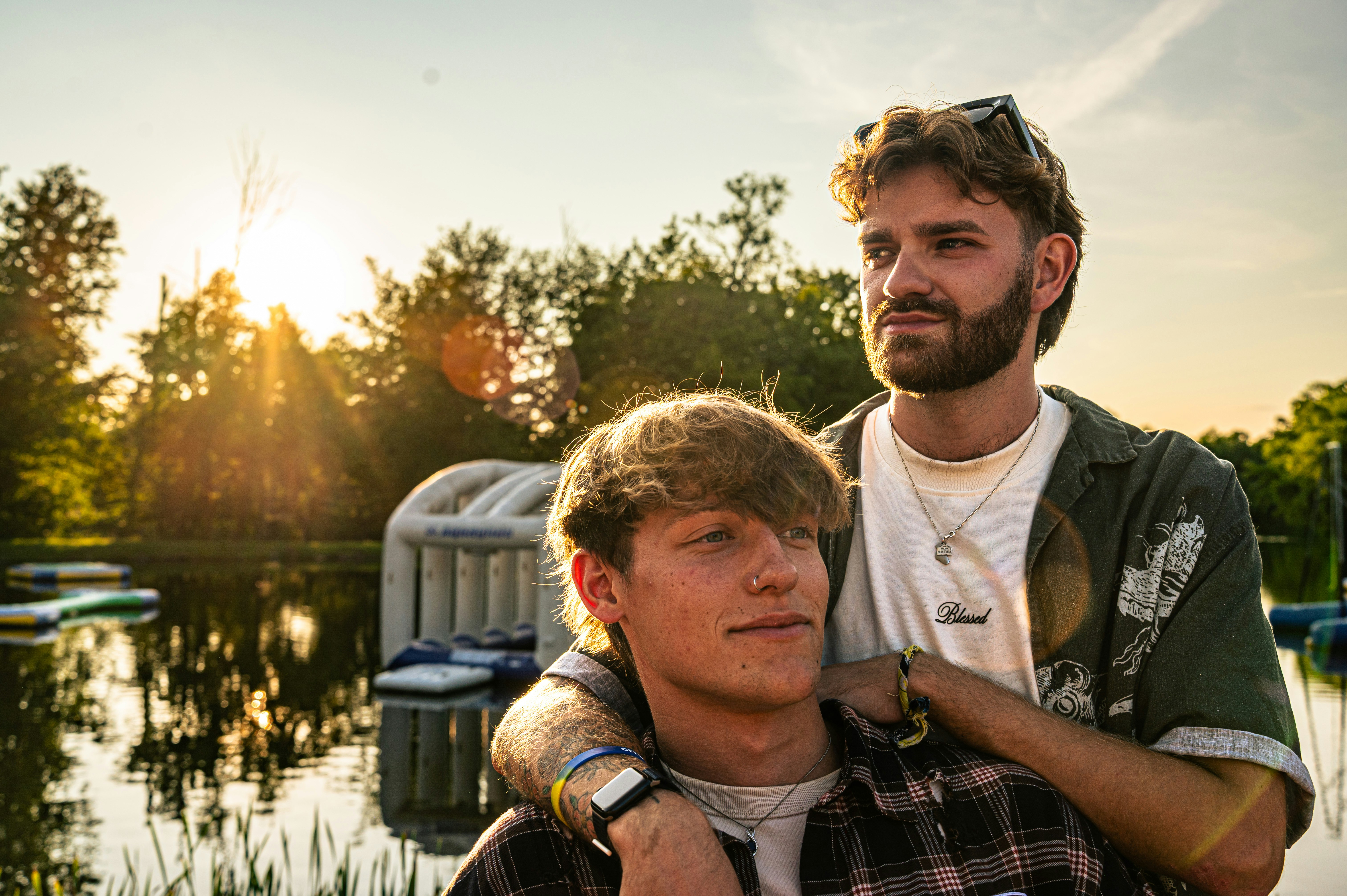 Sunlit Bond: Two Friends at Golden Hour by the Lake