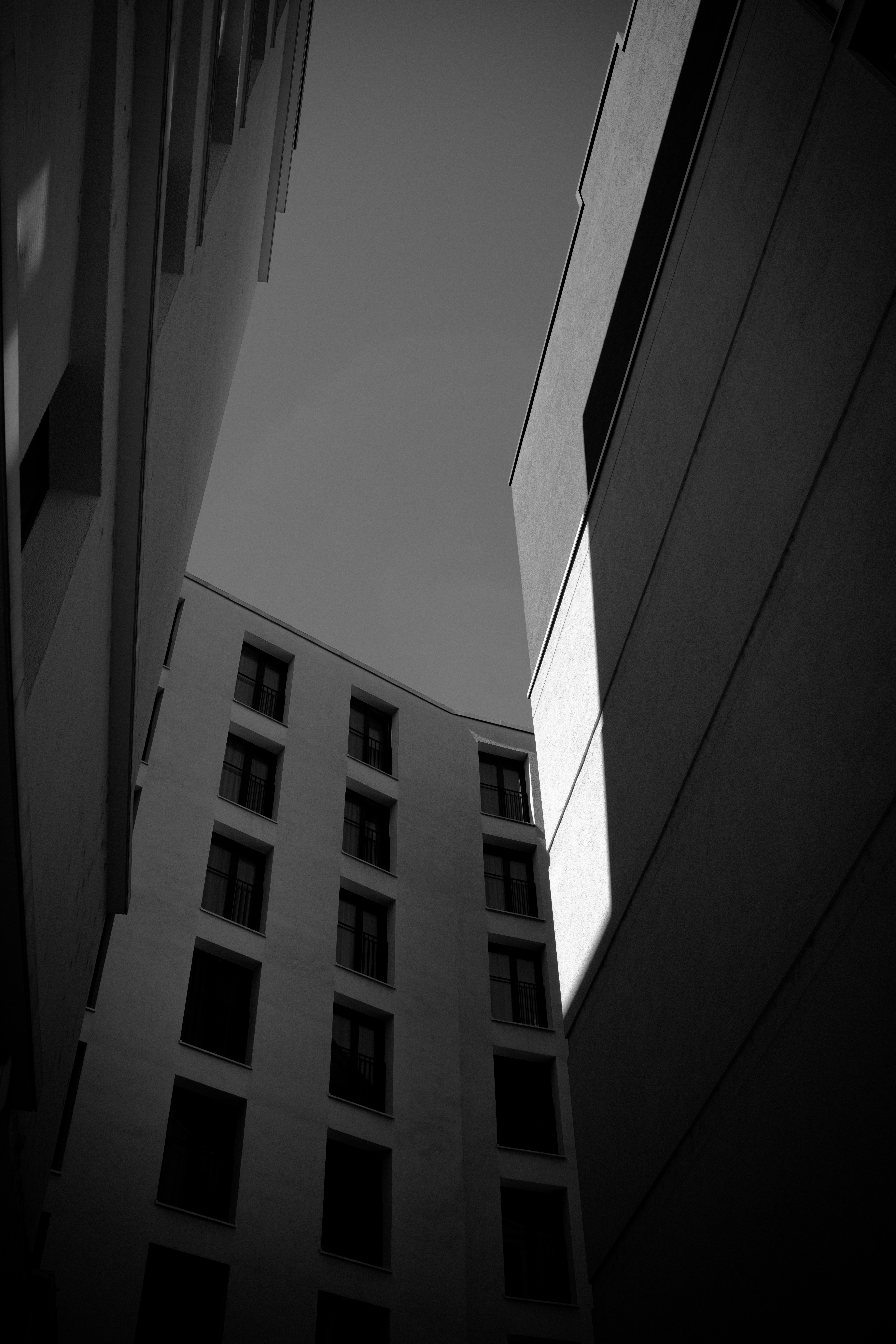 Between Tall Walls: A Quiet Moment in Monochrome Sky