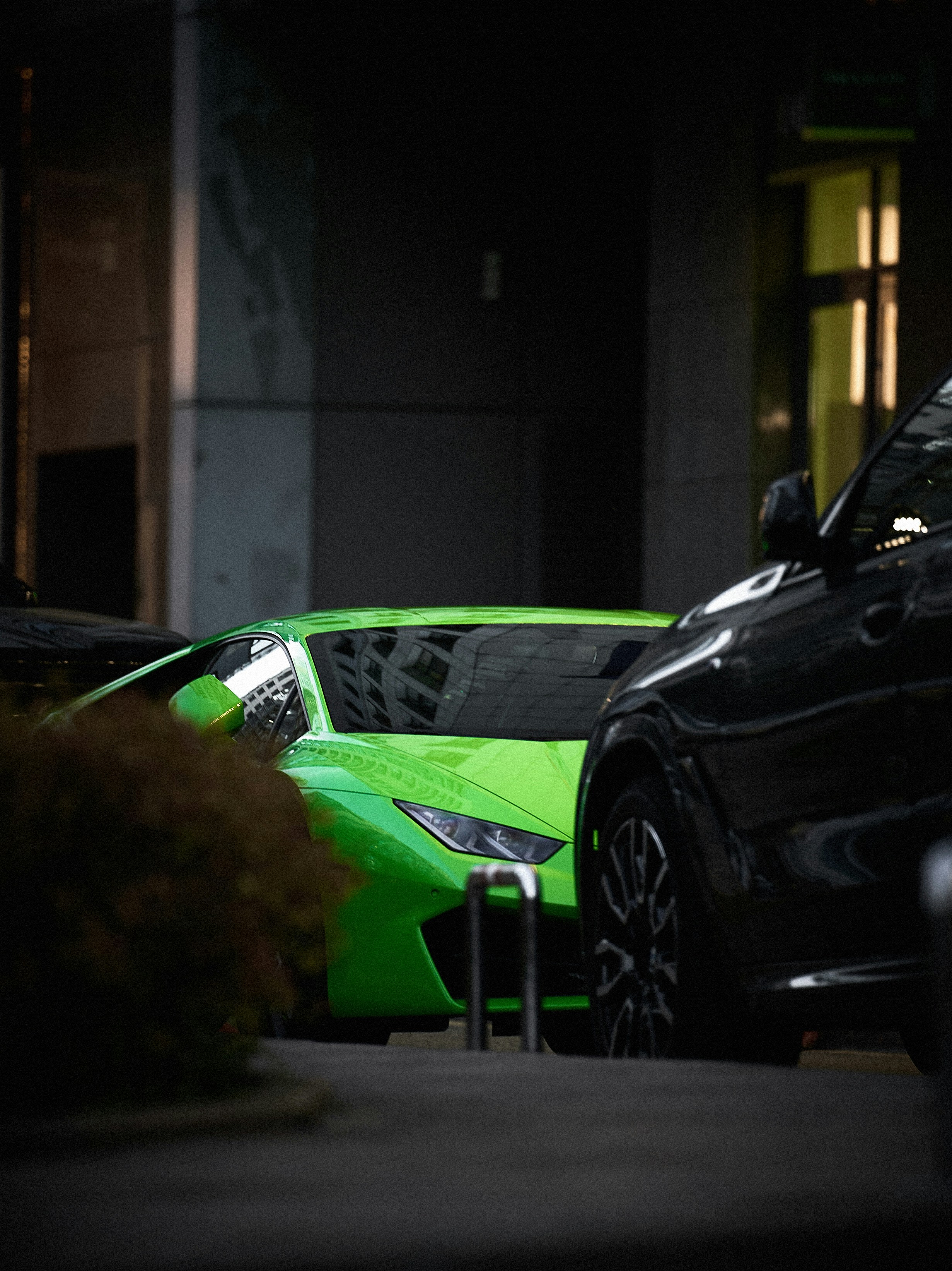 Lime Lamborghini Peek: A Glimpse Between Parked Giants