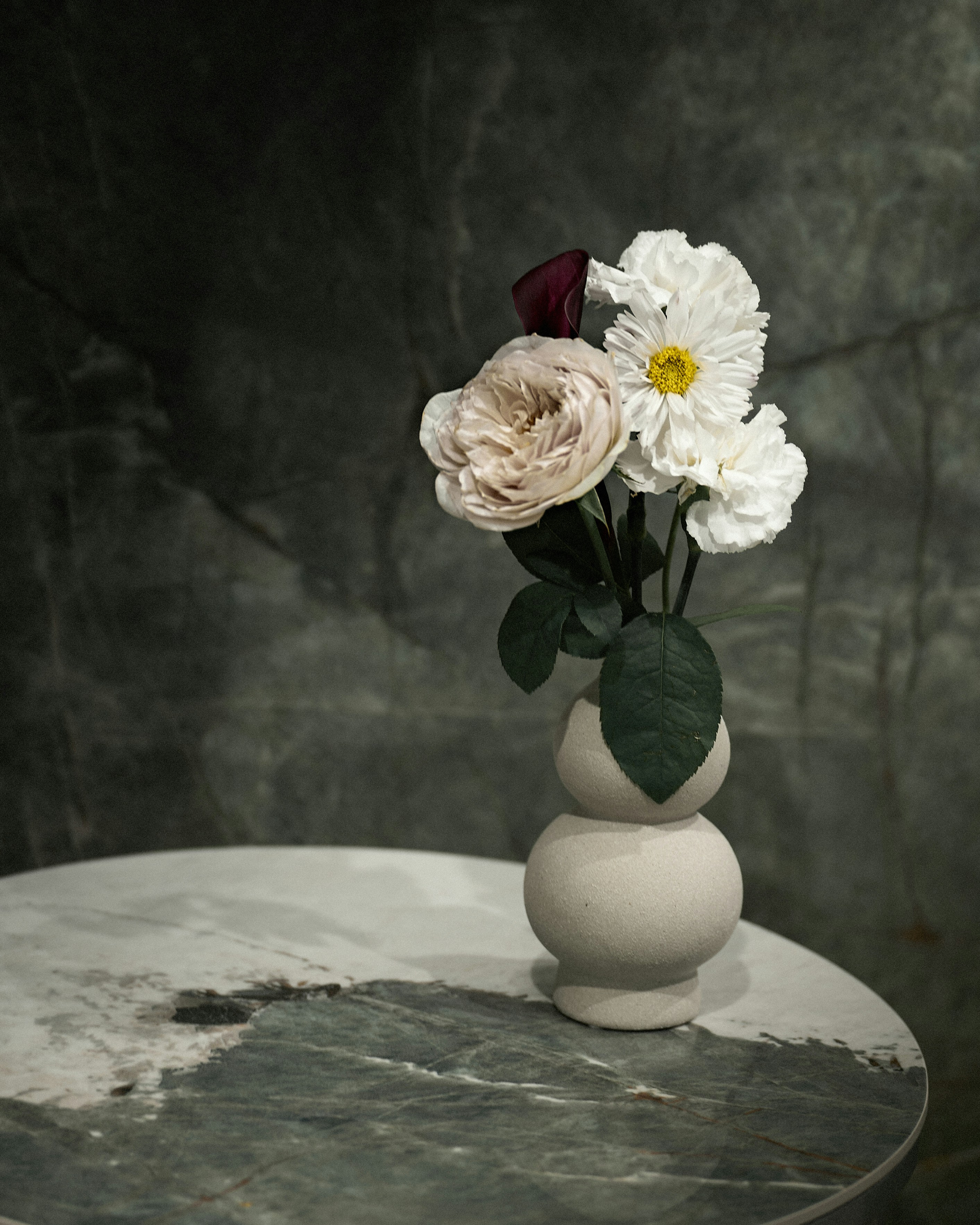 Minimalist still life: porcelain vases cradle peony bouquet