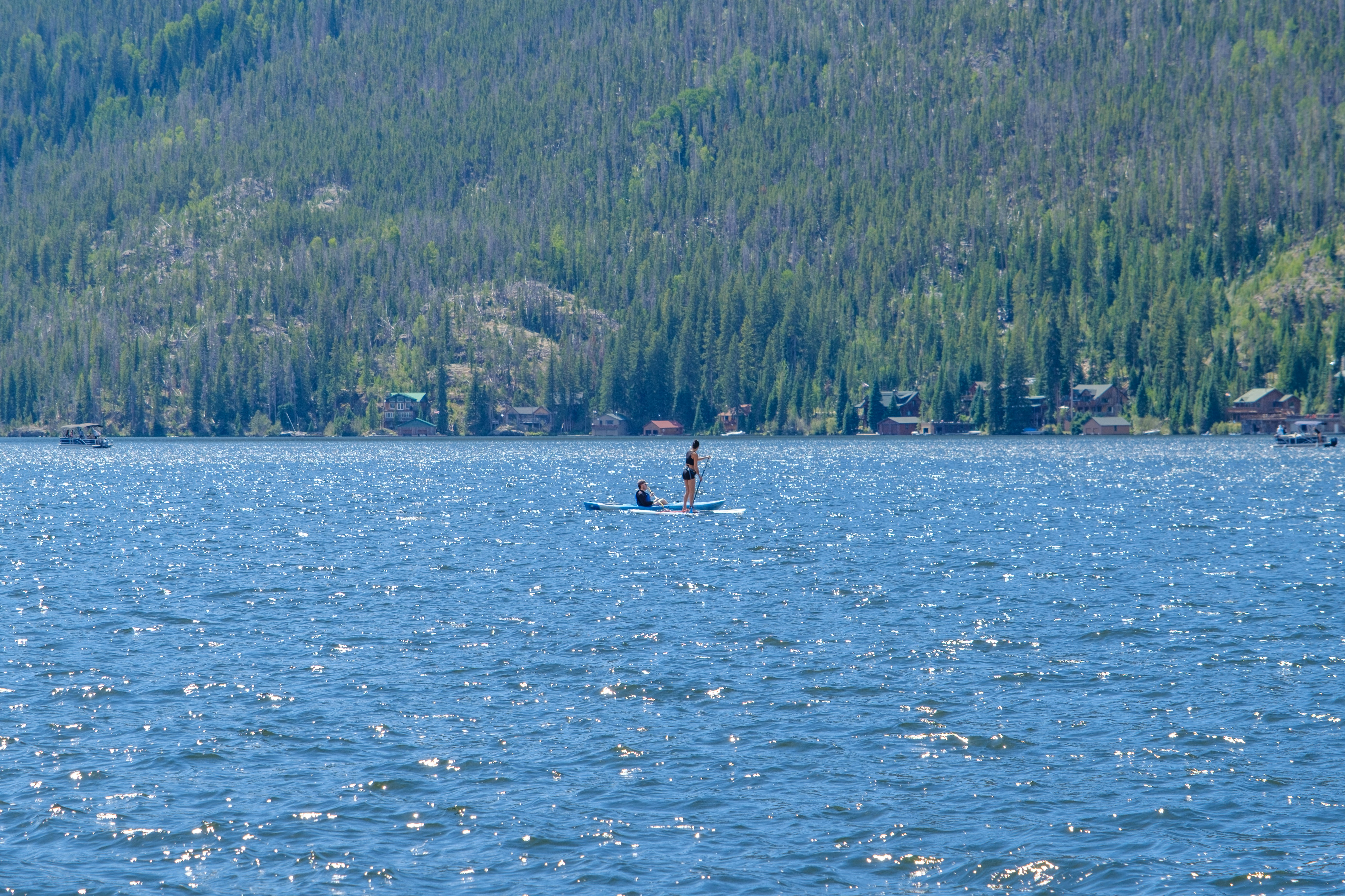 Distant Kayakers on a Sparkling Mountain Lake