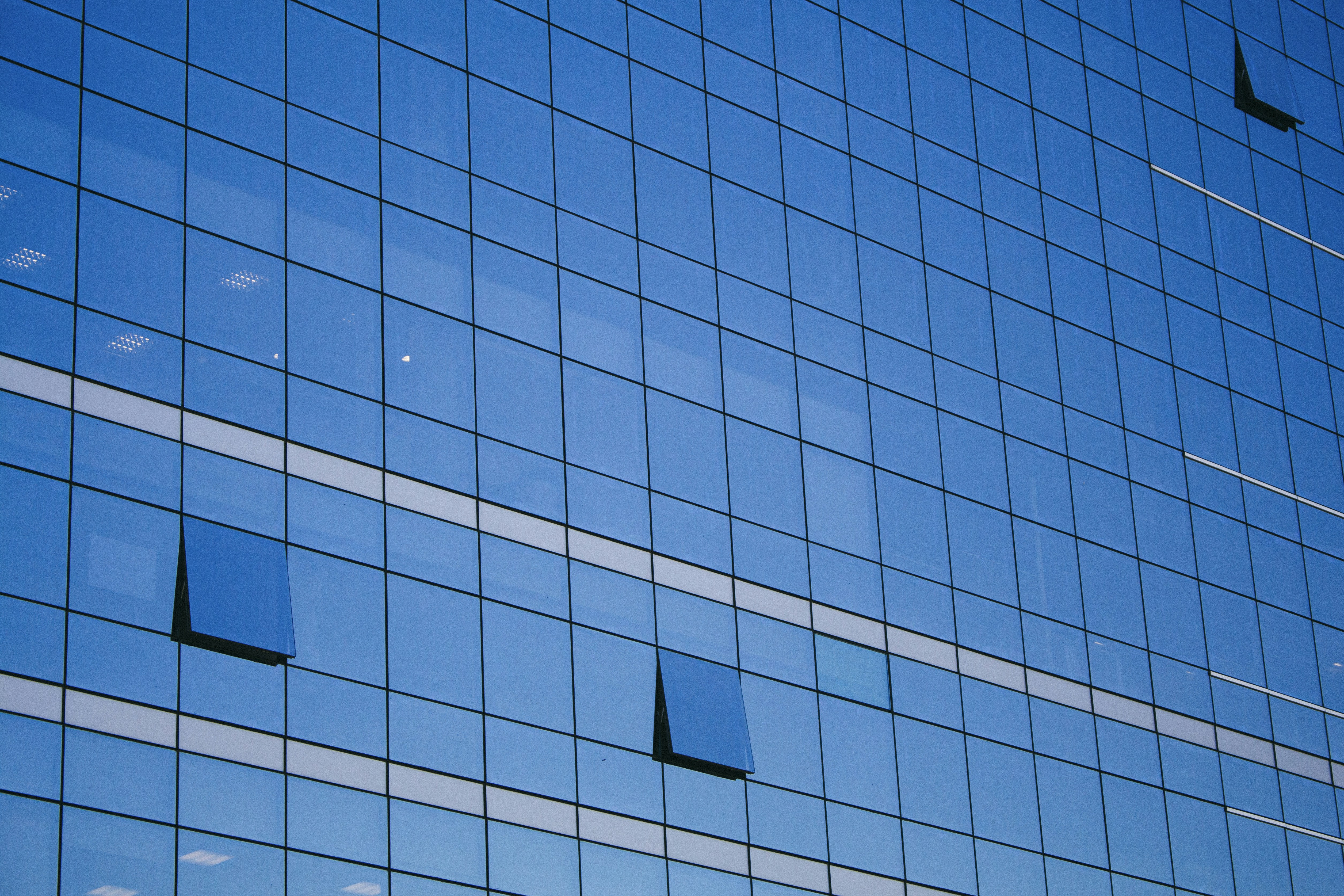 Blue Glass Mosaic: A Faceted Skyline on the Corporate Facade
