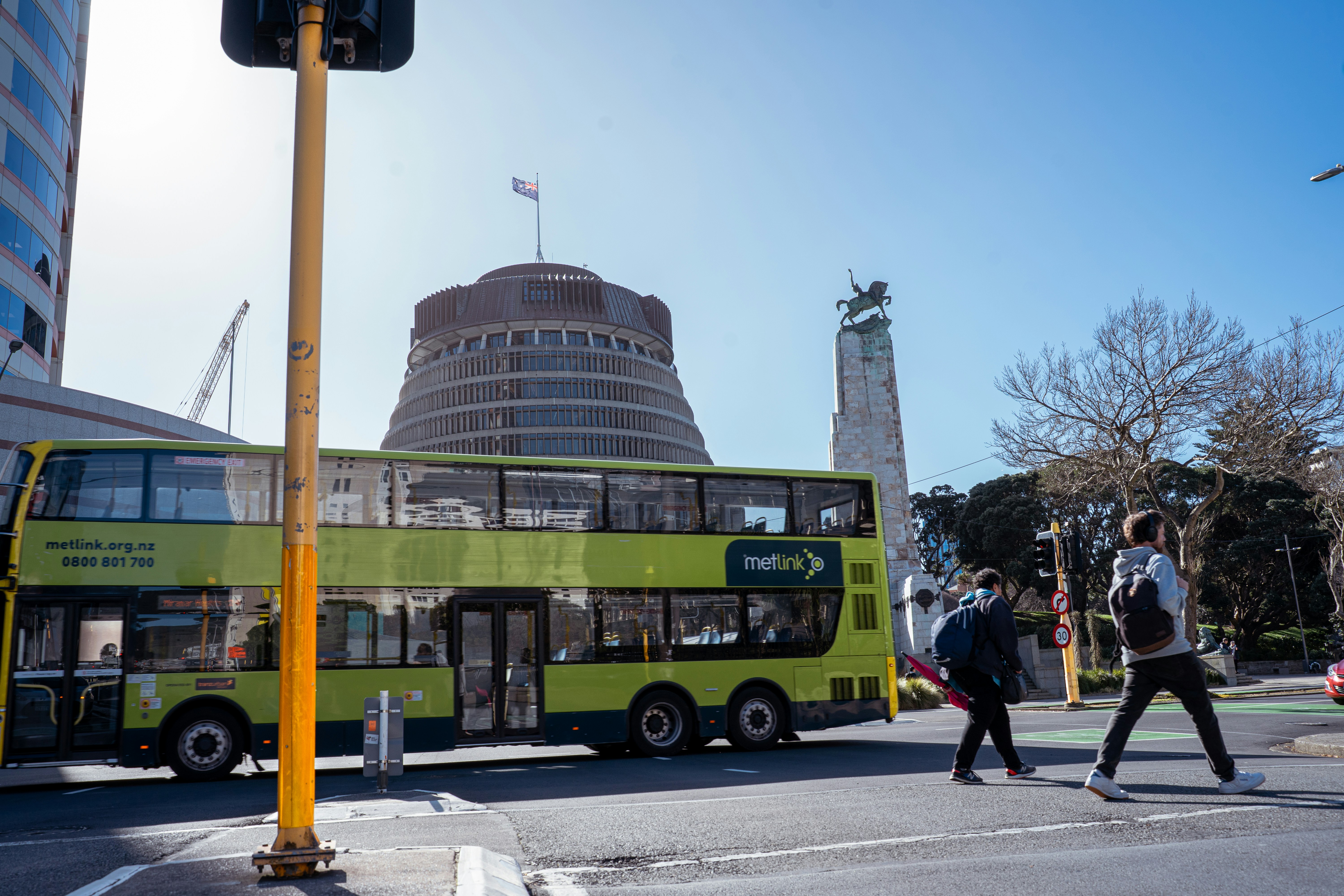 Urban Transit in Motion: A Green Double-Decker by the City Clock