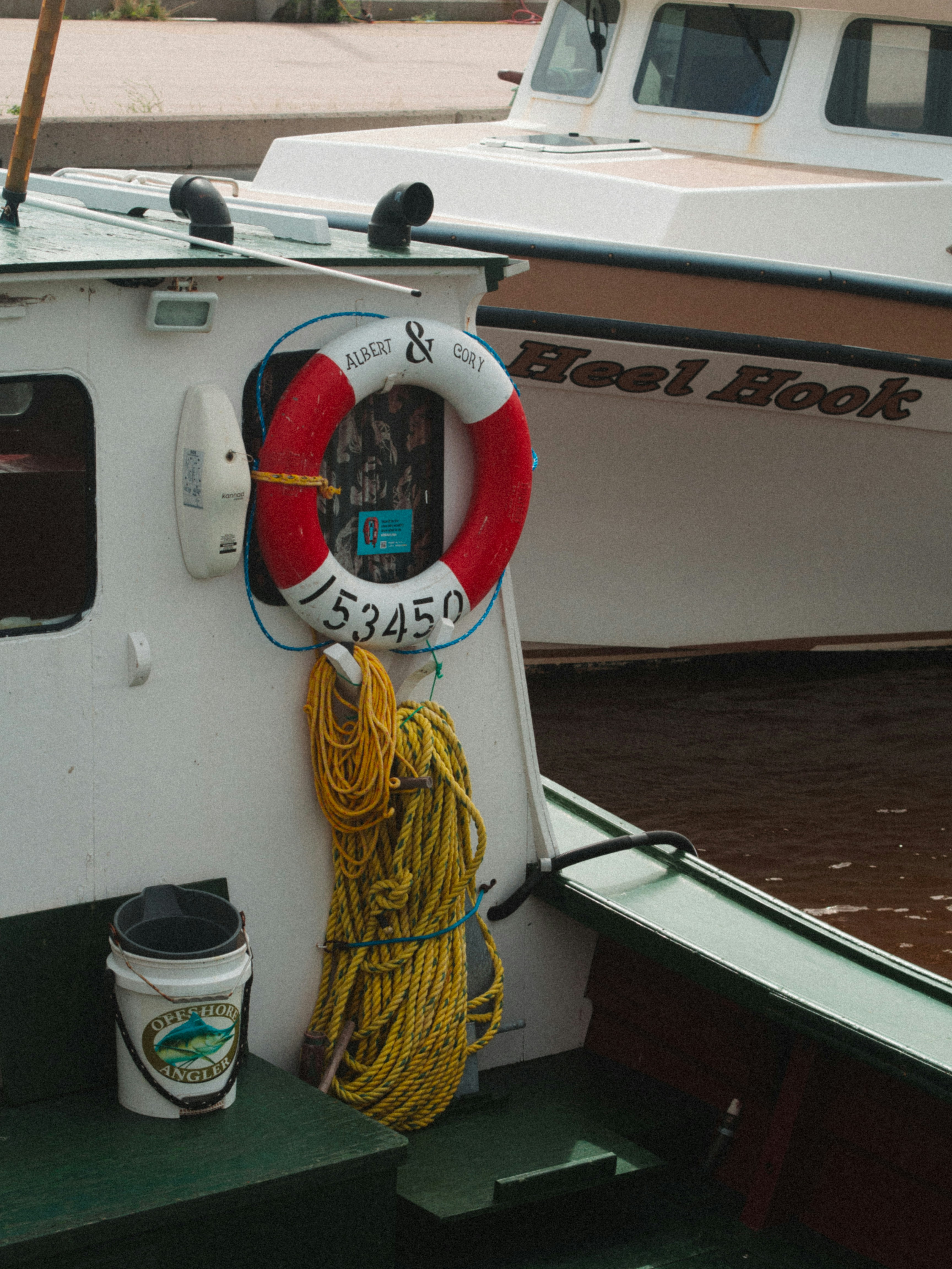 Lifebuoy and Coiled Rope on Docked Boat