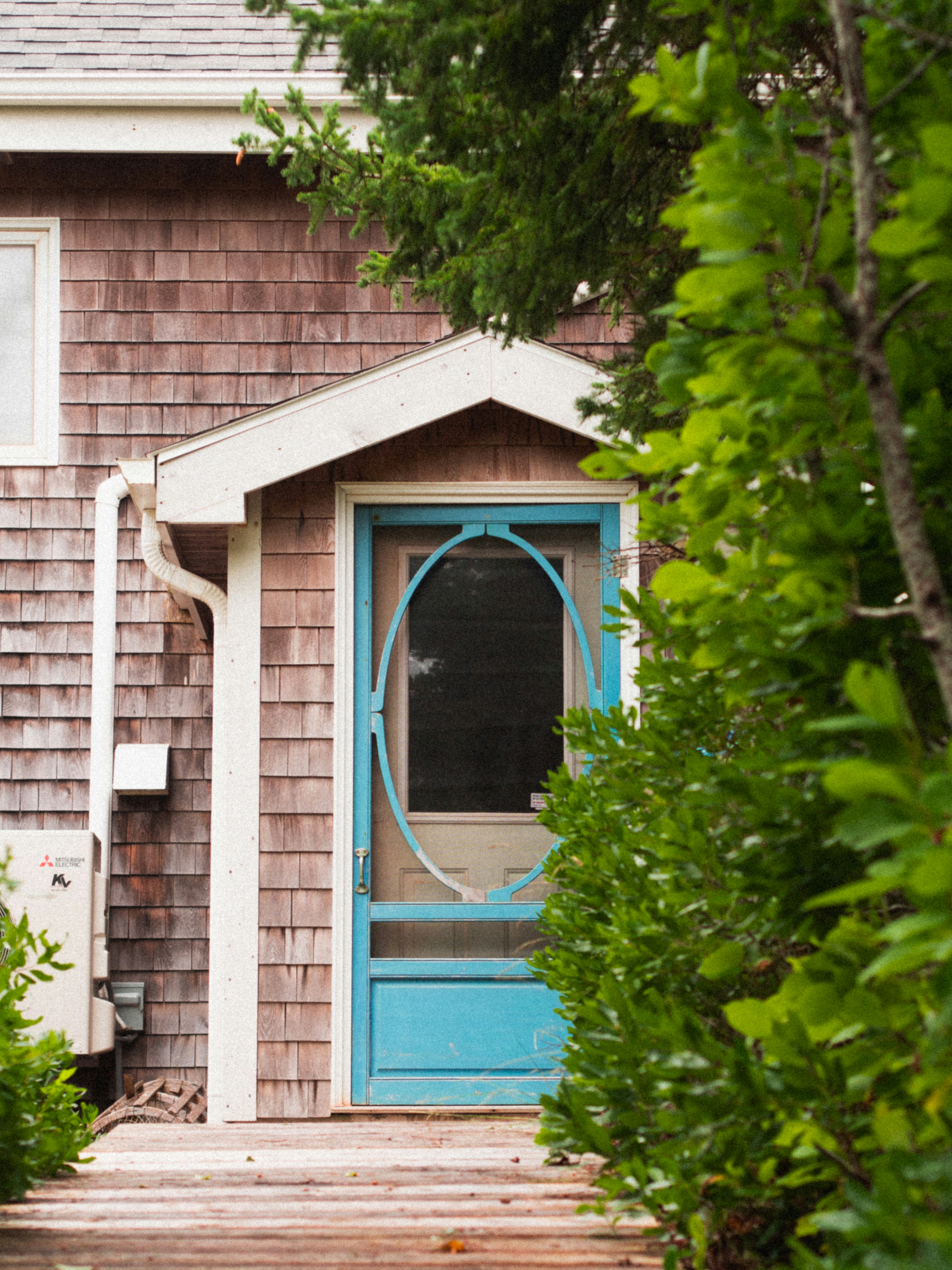 Azure Doorway Framed by Narrow Greenery