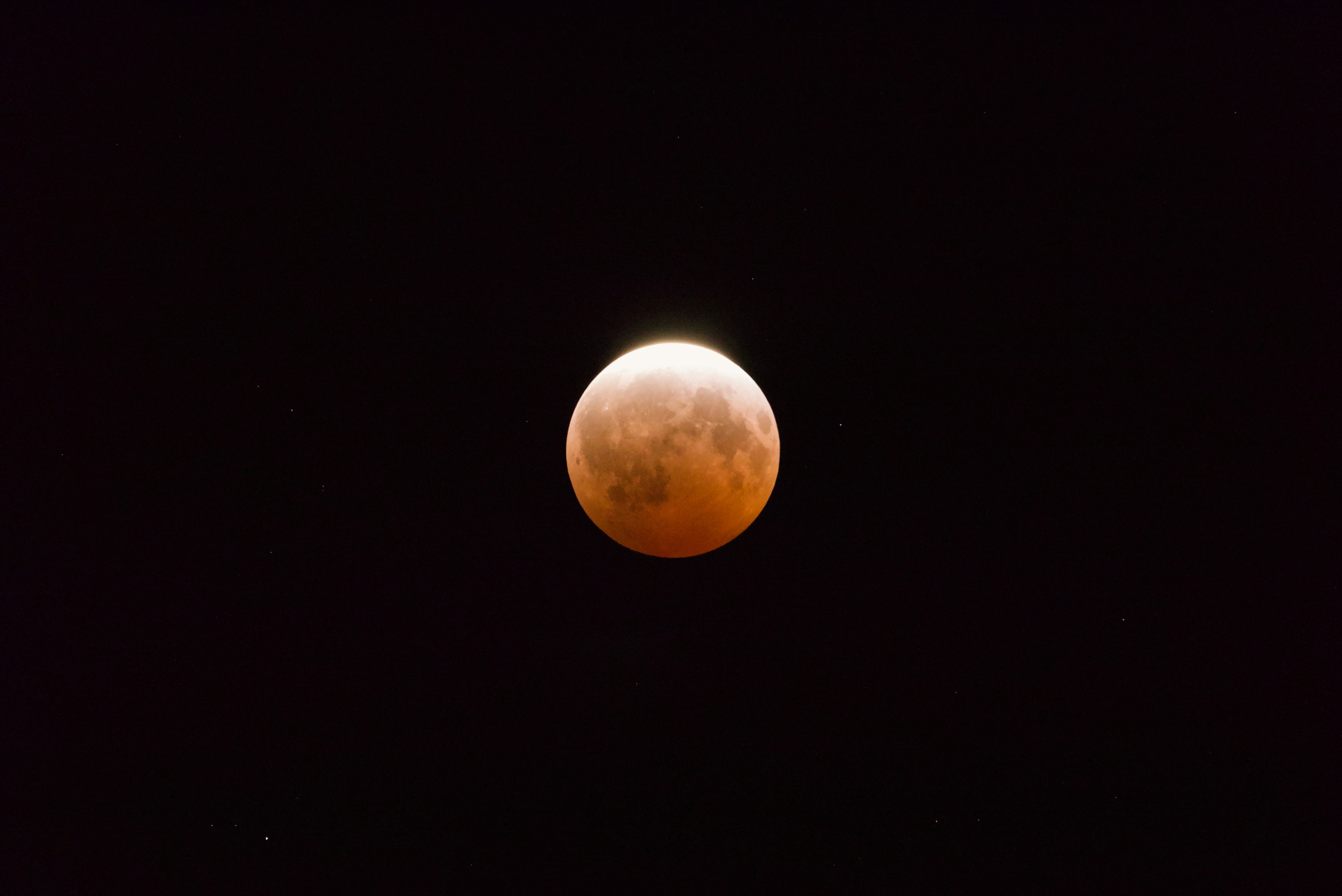 Moon in Partial Lunar Eclipse: A Coppery Halo in Dark Skies