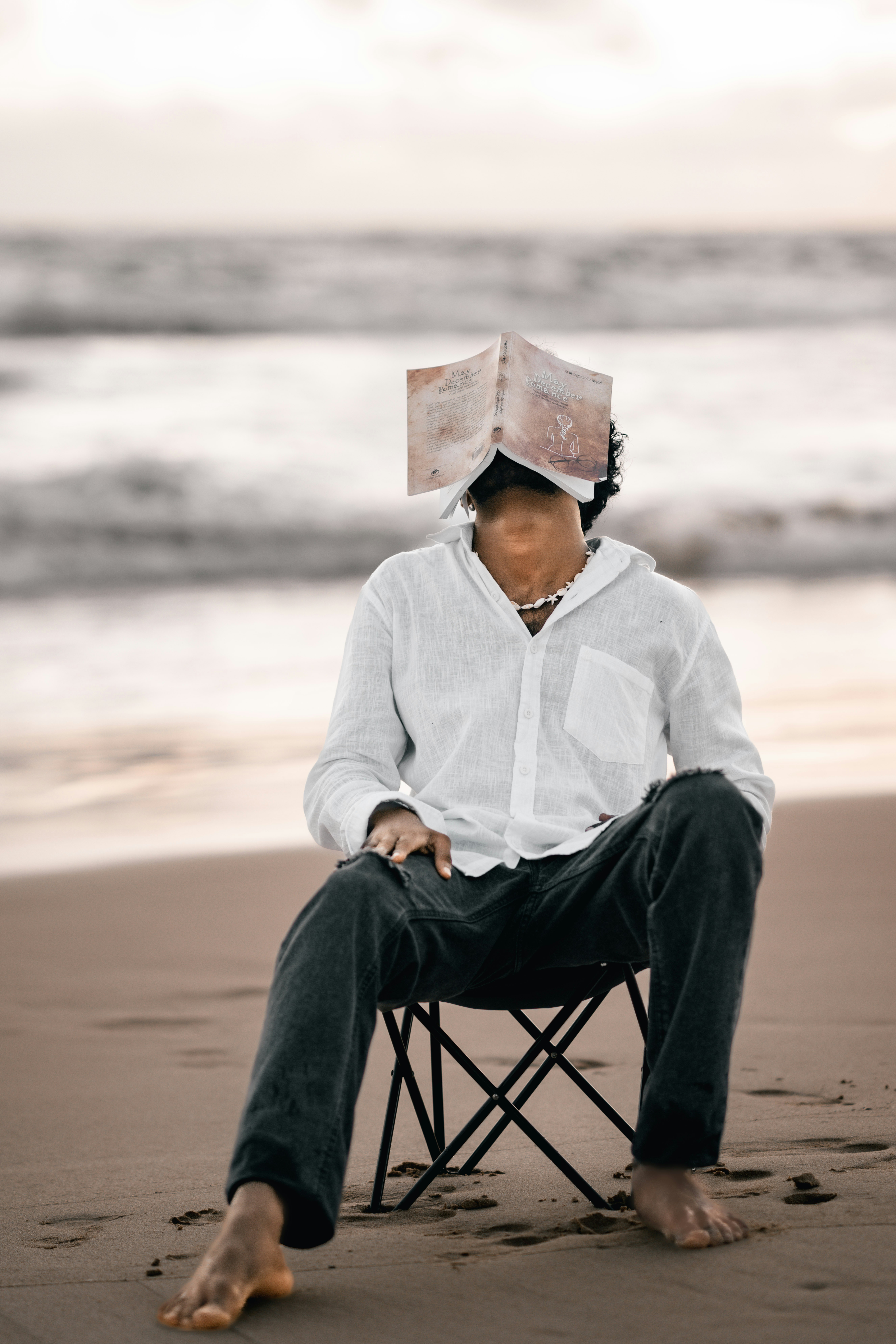 Seaside Stillness: A Reader in the Sunset Wind