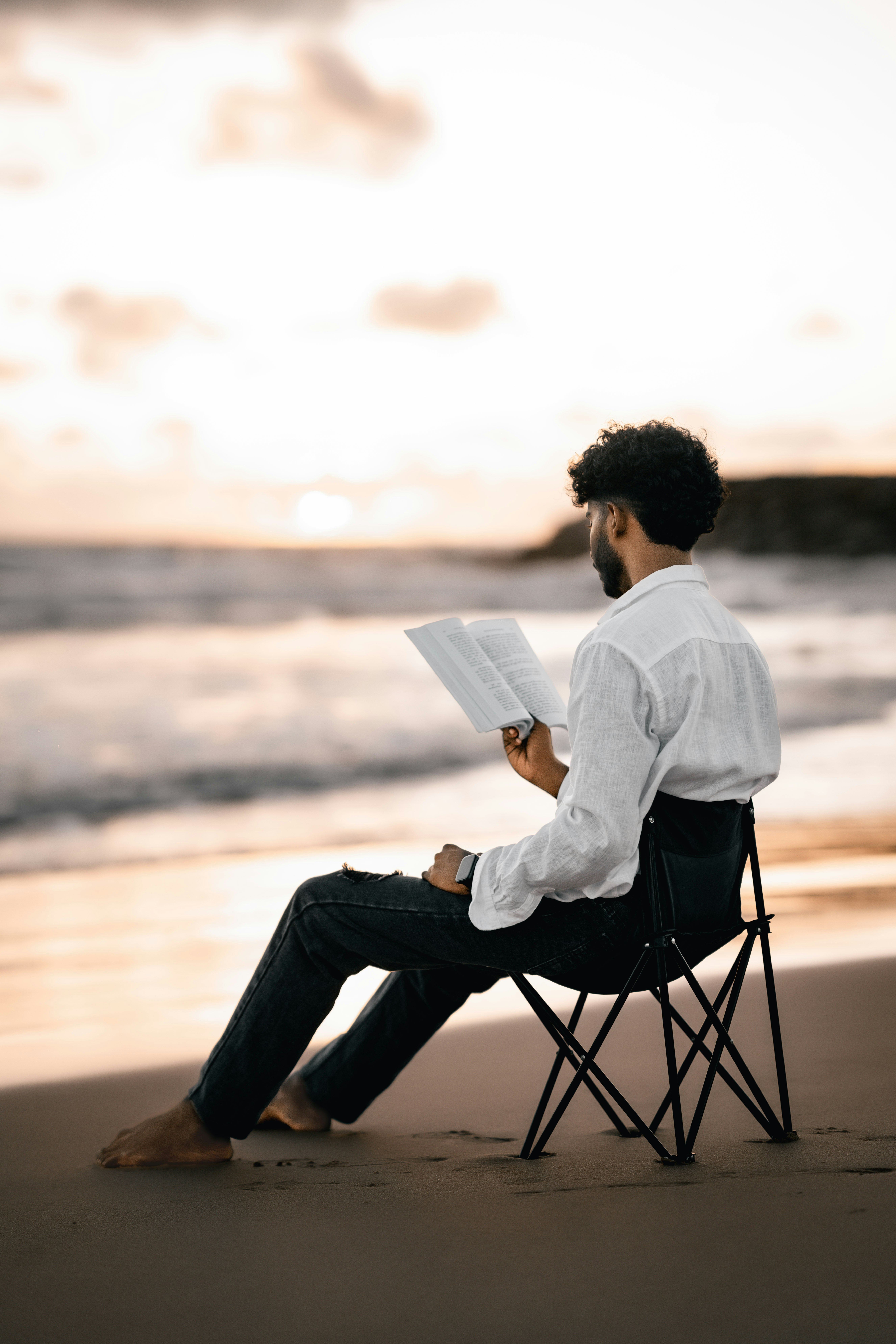 Seated Reader by Sunset: A Quiet Moment on the Shore