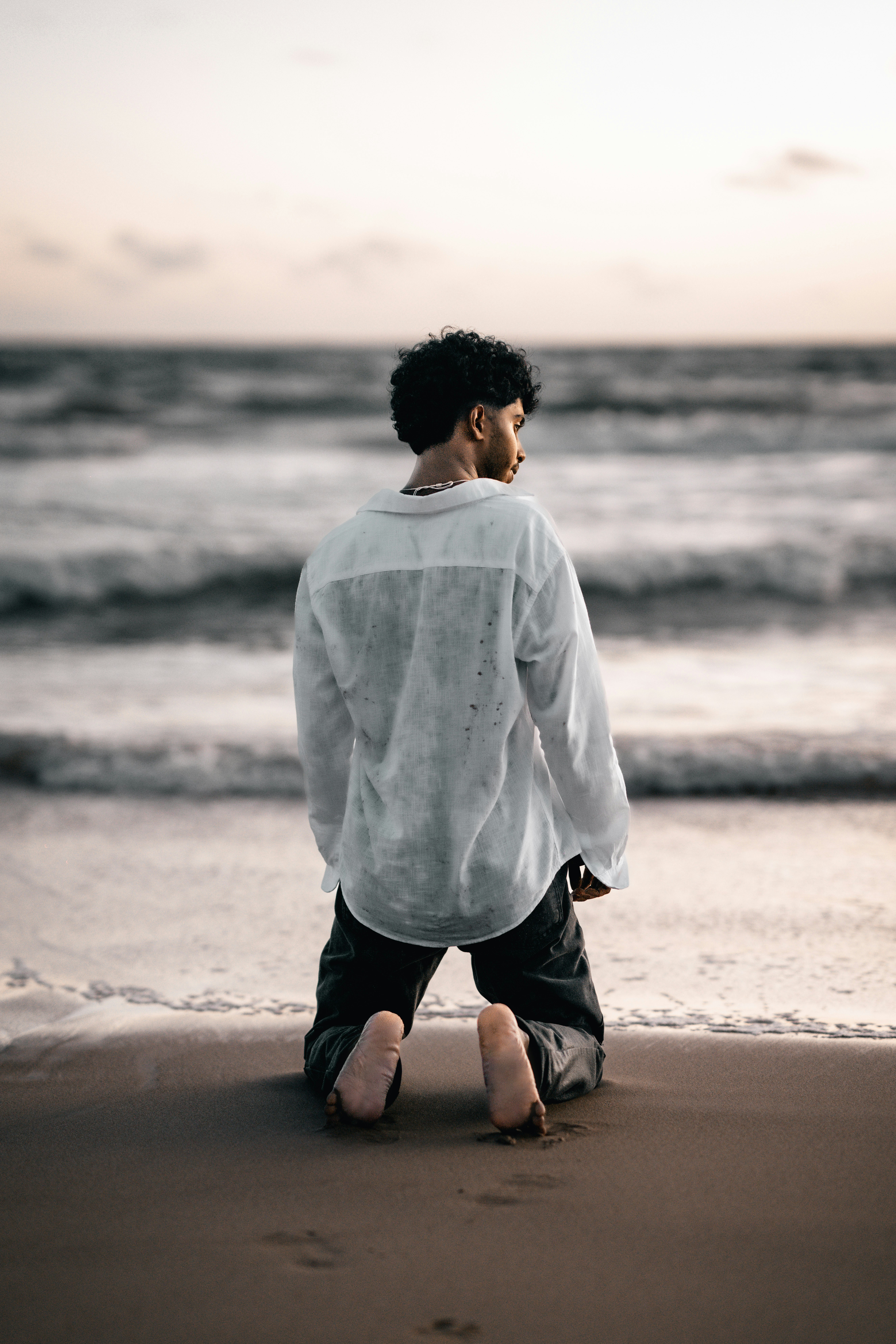 Sea-kissed Quiet: Kneeling by the Tides