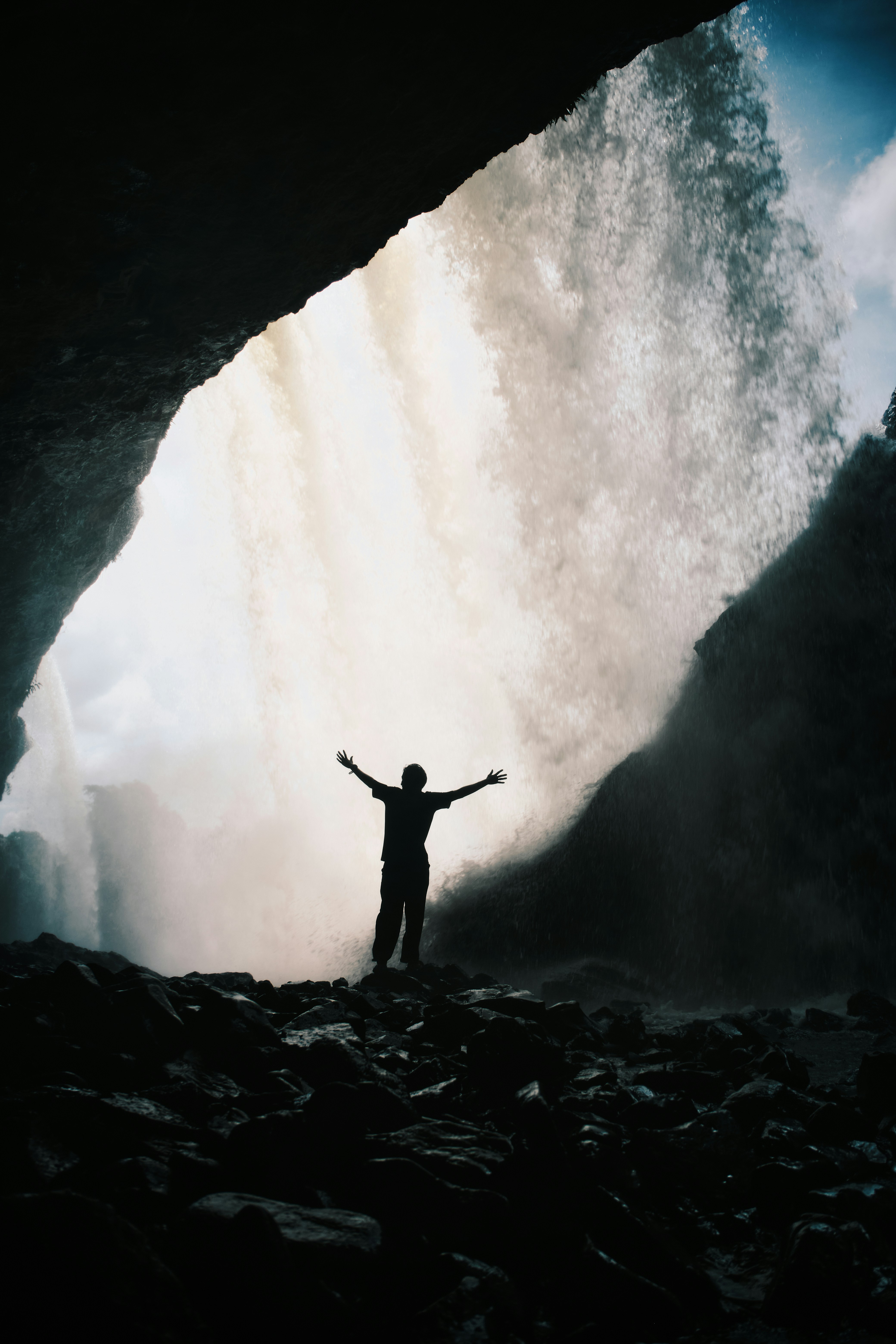A Silhouette Beneath the Vagrant Cascade
