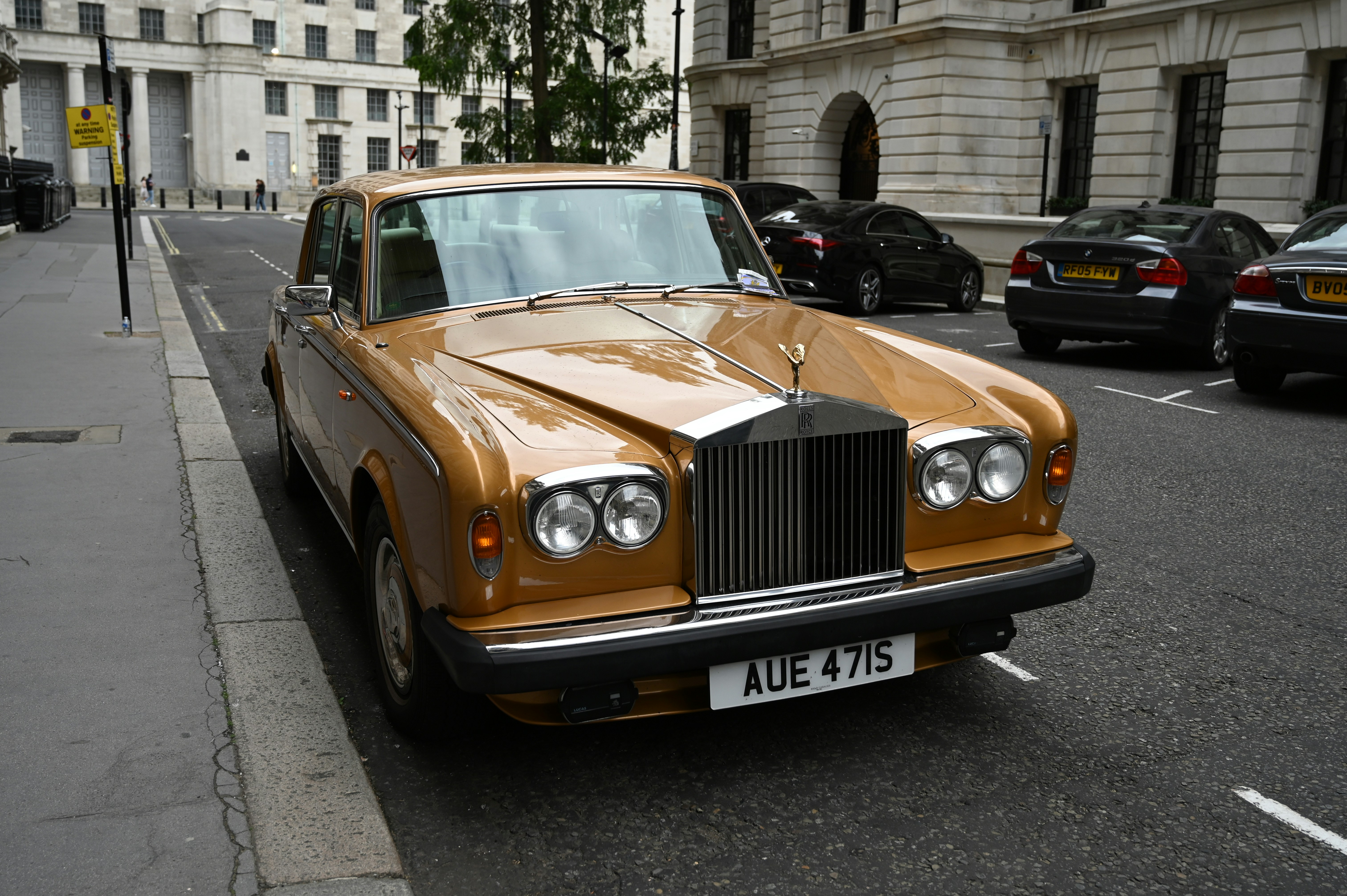 Golden Spirit on the City Street: A Classic Rolls-Royce Beckons