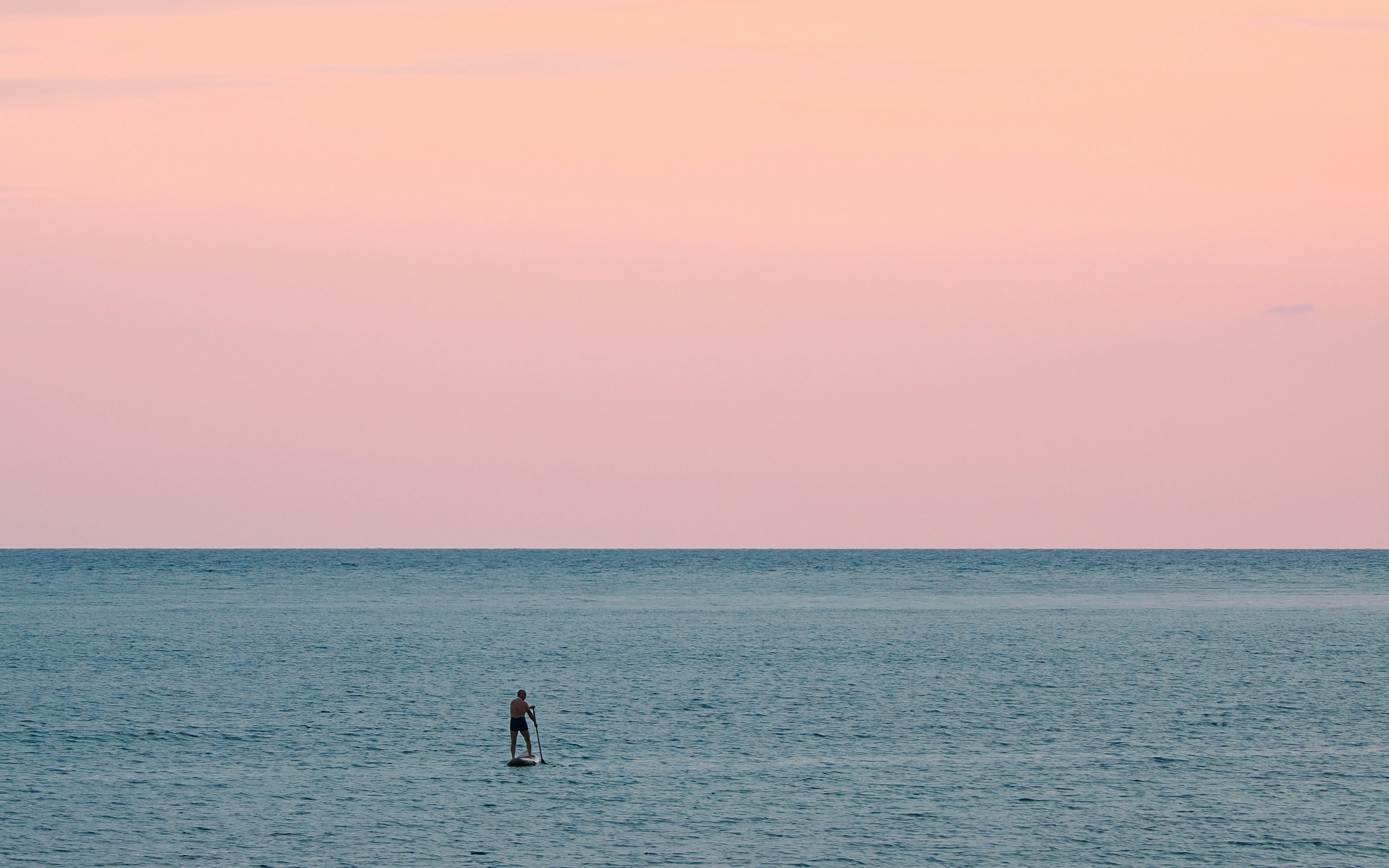 Horizon Whisper: lone paddleboarder at sunset