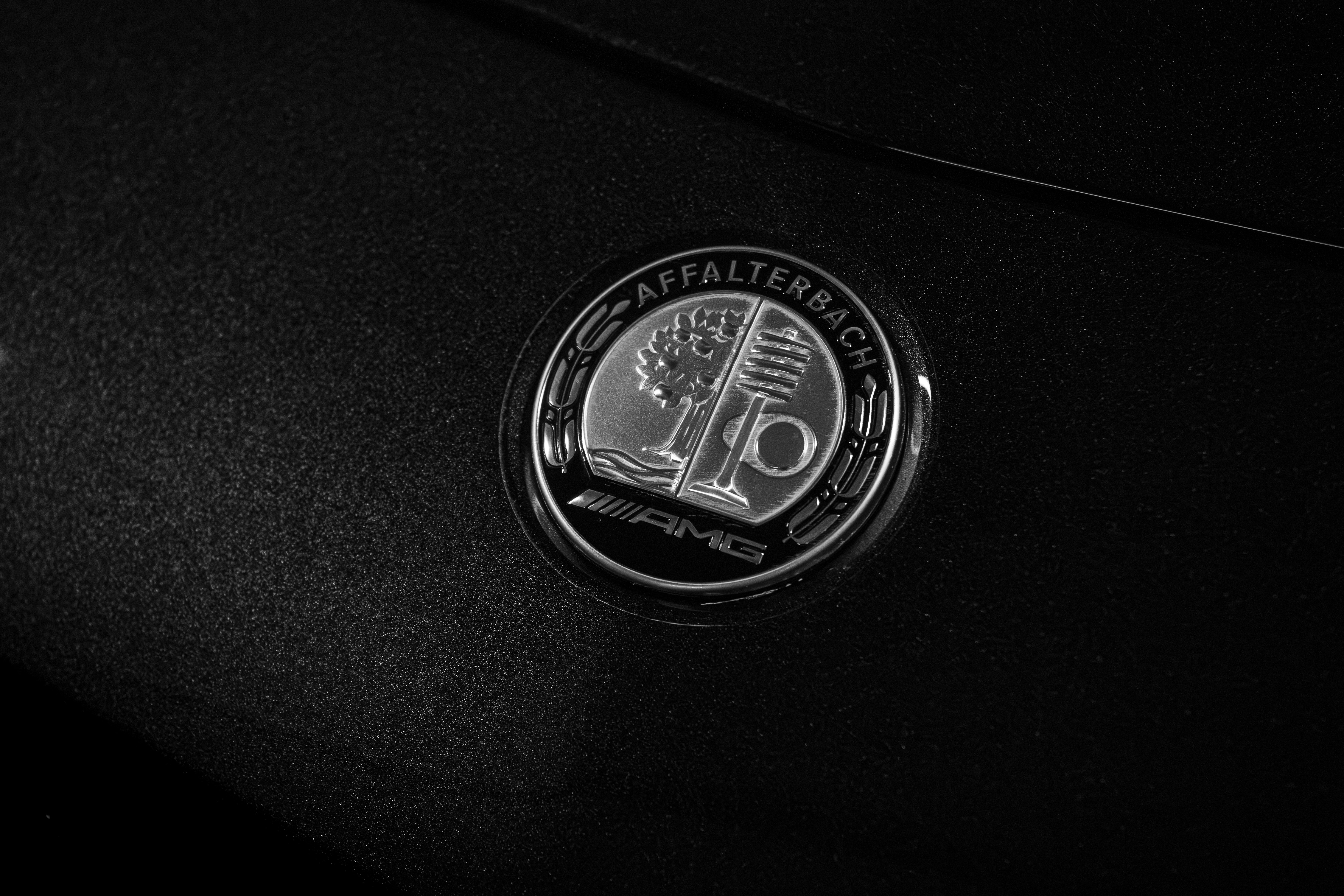 Mercedes-Benz AMG emblem on a dark, textured surface