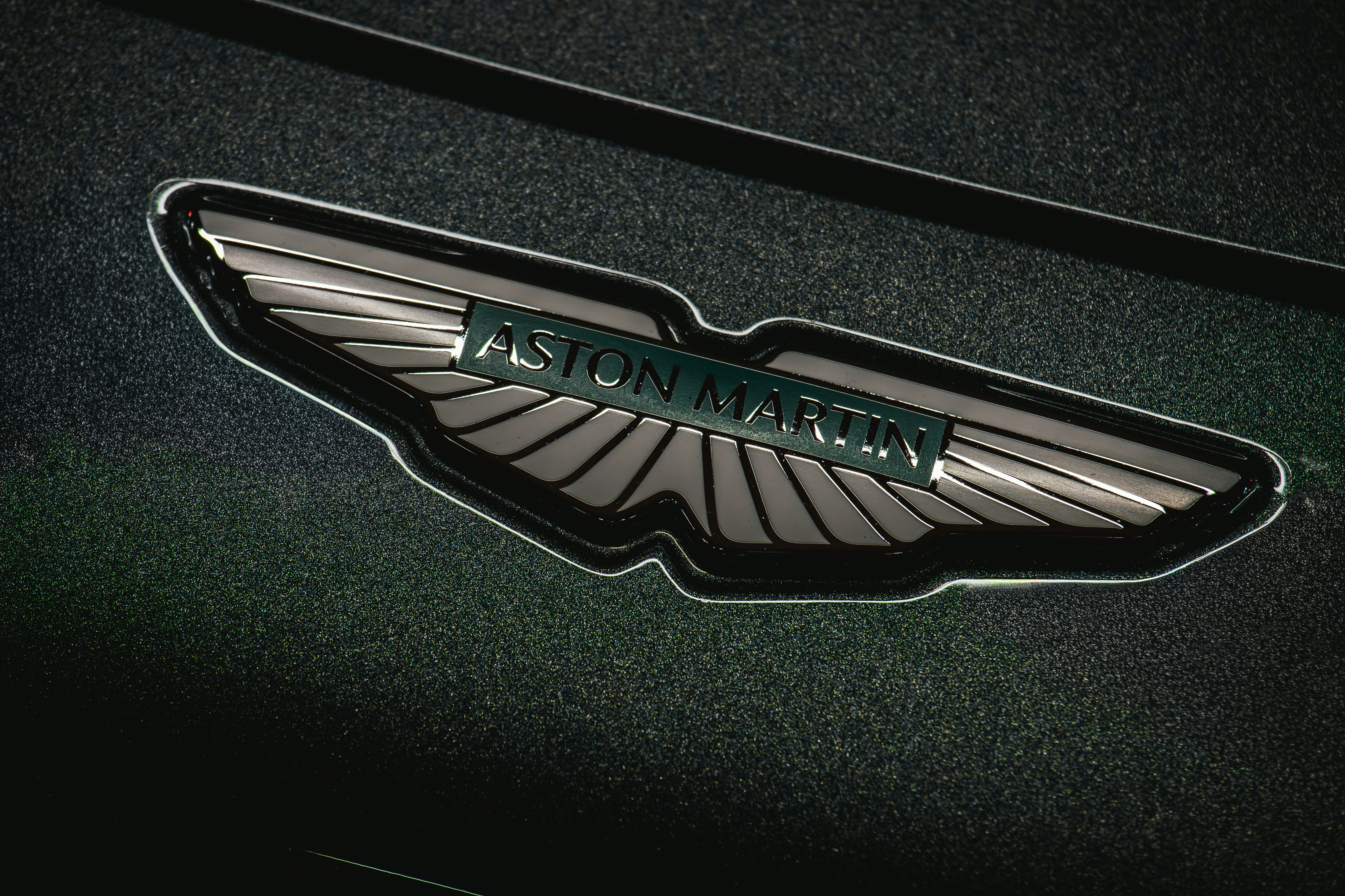 Emblem in Focus: The Aston Martin Crest Glinting on Night-Cainted Metal