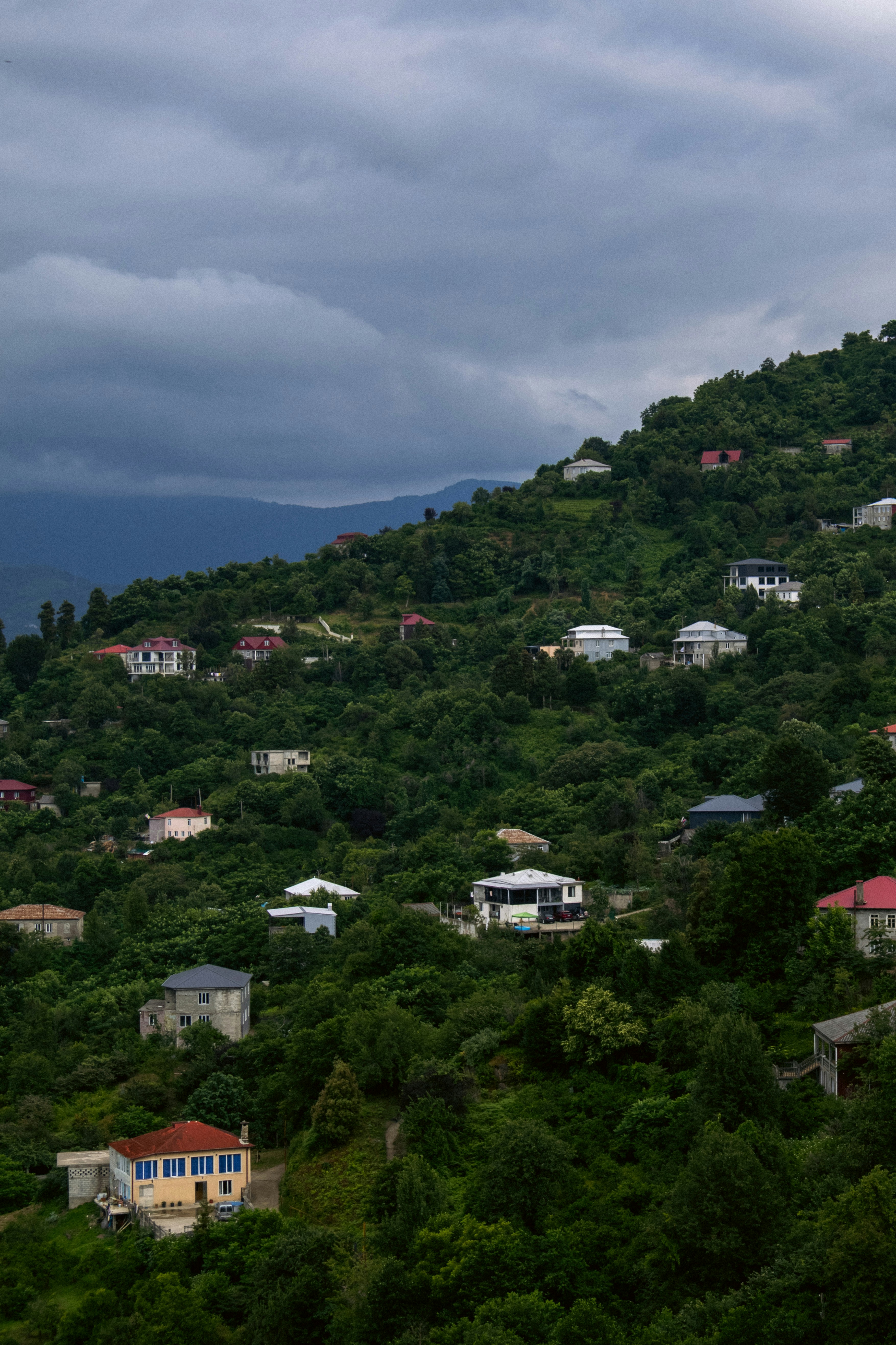 Terraced hillside villages under brooding clouds