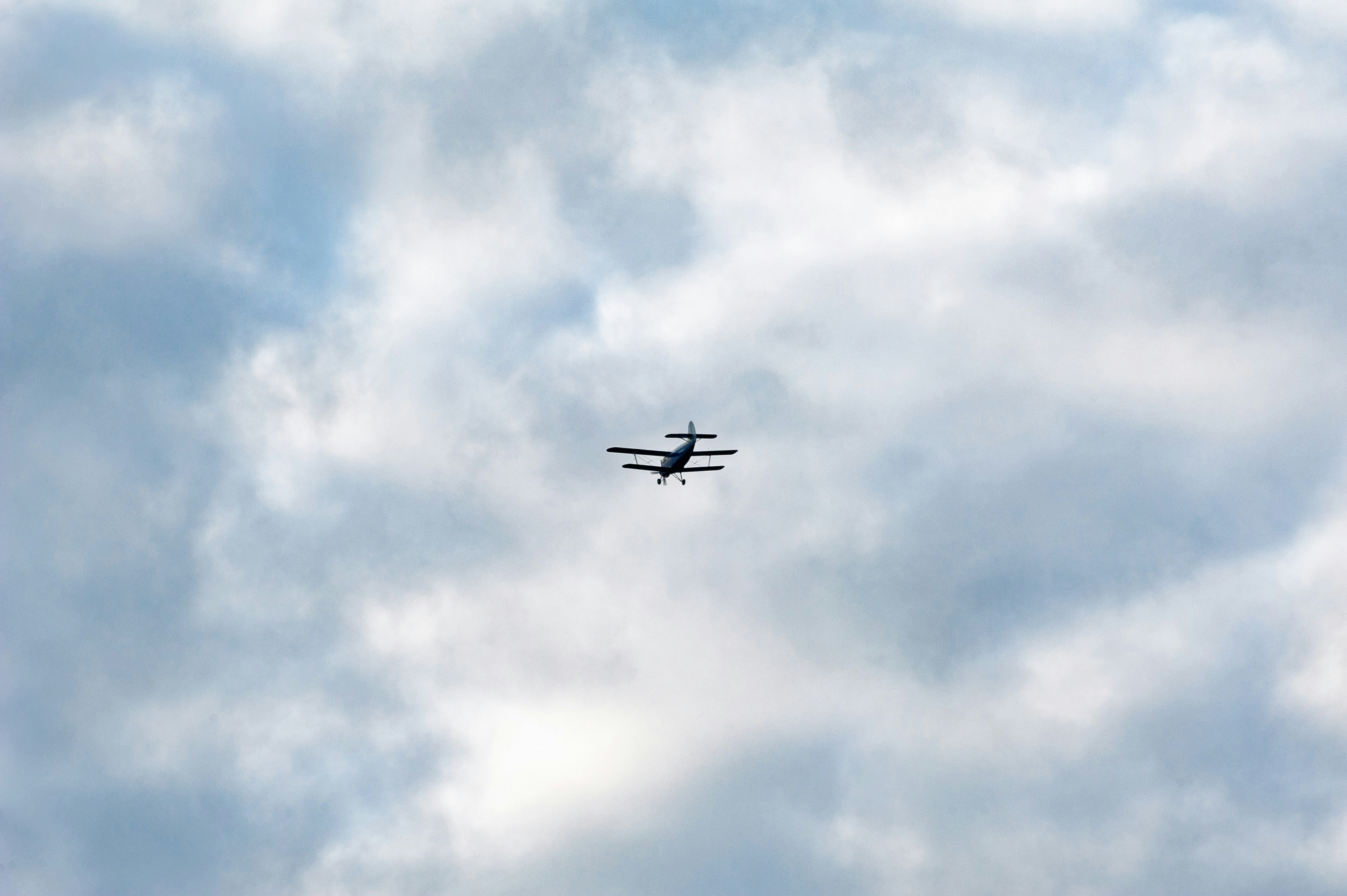 Twin-Prop Silhouette: A Skyward Pass Over a Cloud-Laced Horizon