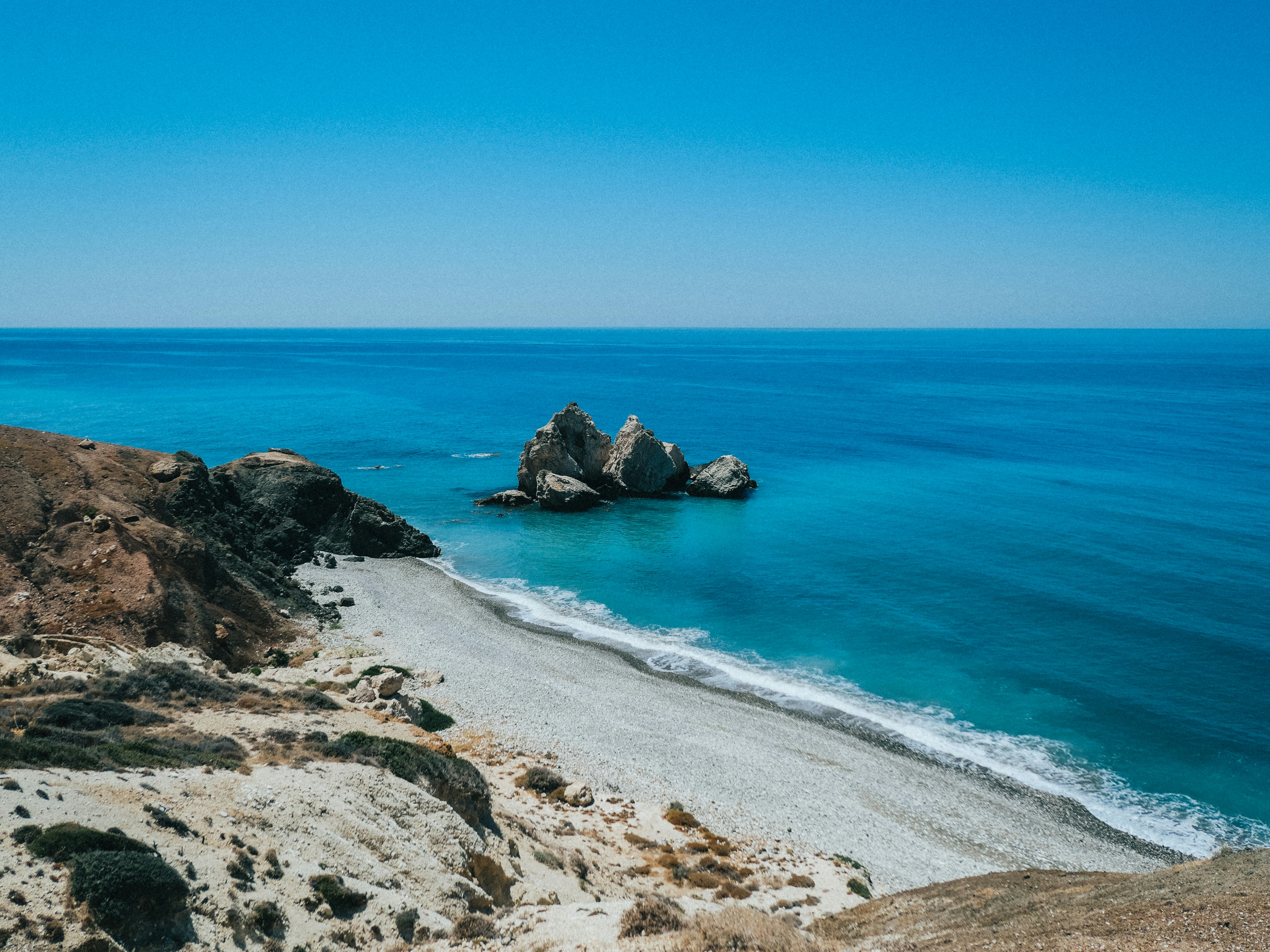 Coastal Left Snag: A Quiet Sea Embraces the Pebble Beach