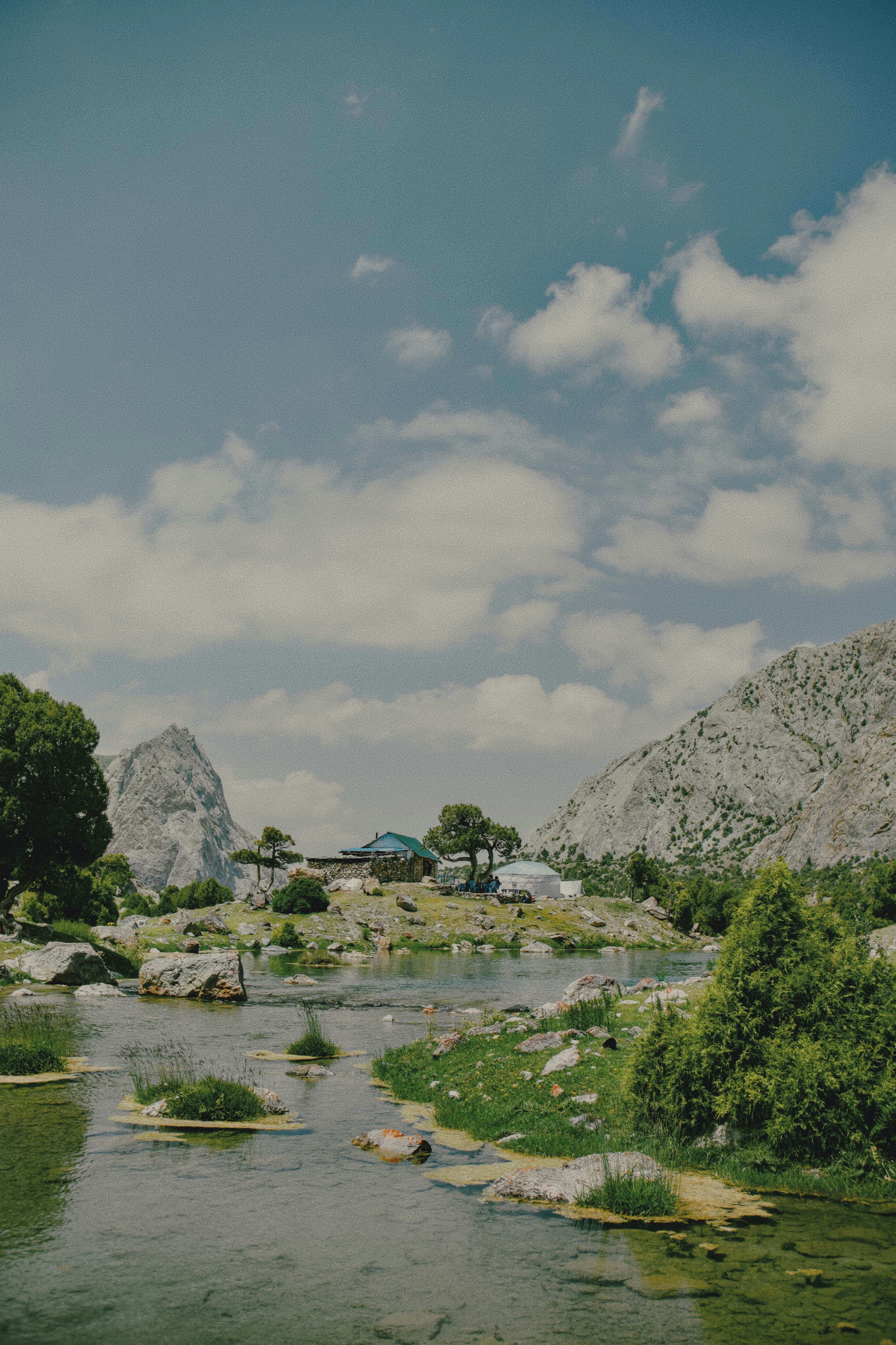 Tranquil Gorge: Village and River Nestled Between Stones