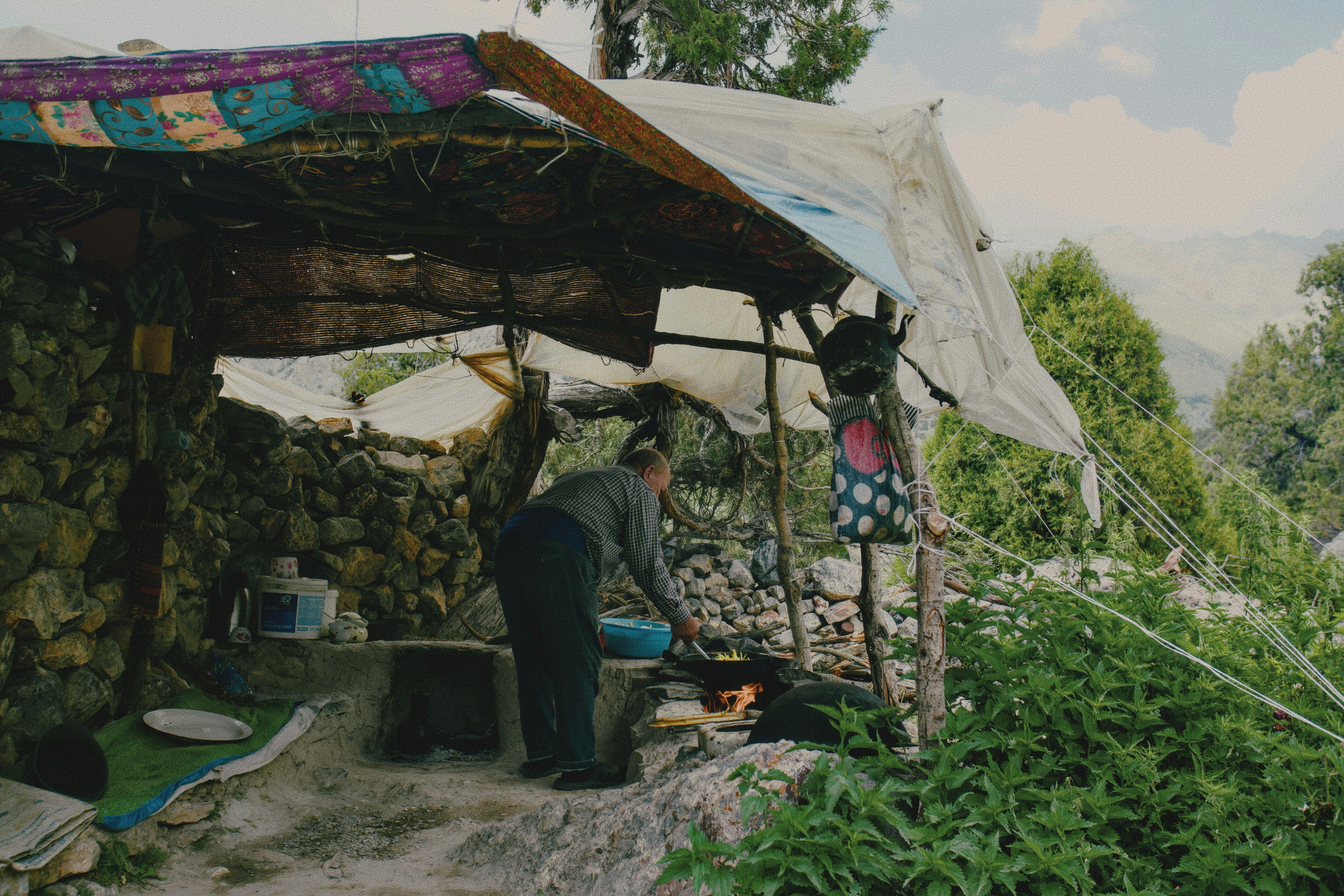 Campside Kitchen Under a Tarped Roof in a Mountain Clearing
