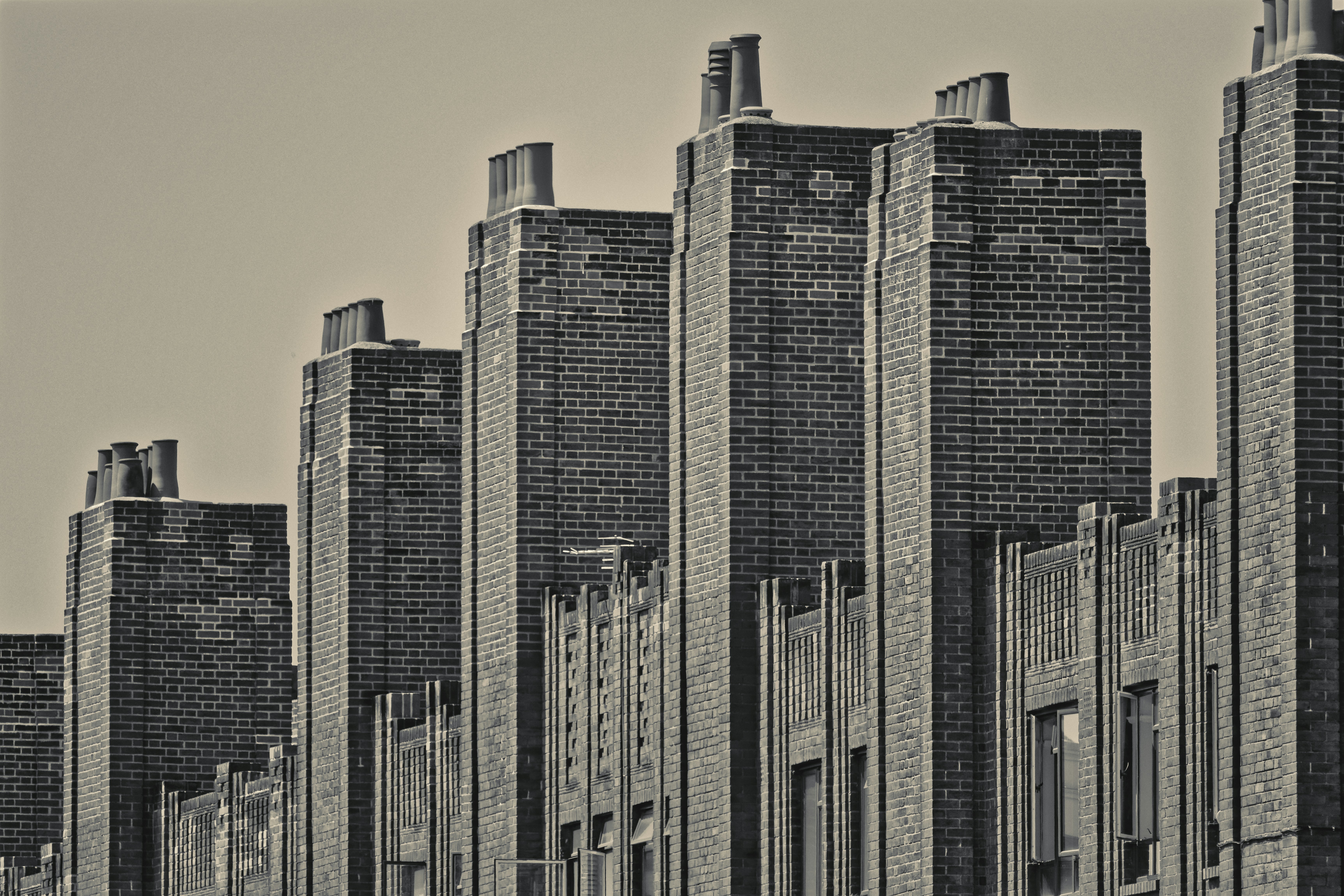 Chimneys and Brickline: A Monochrome Row of Urban Columns