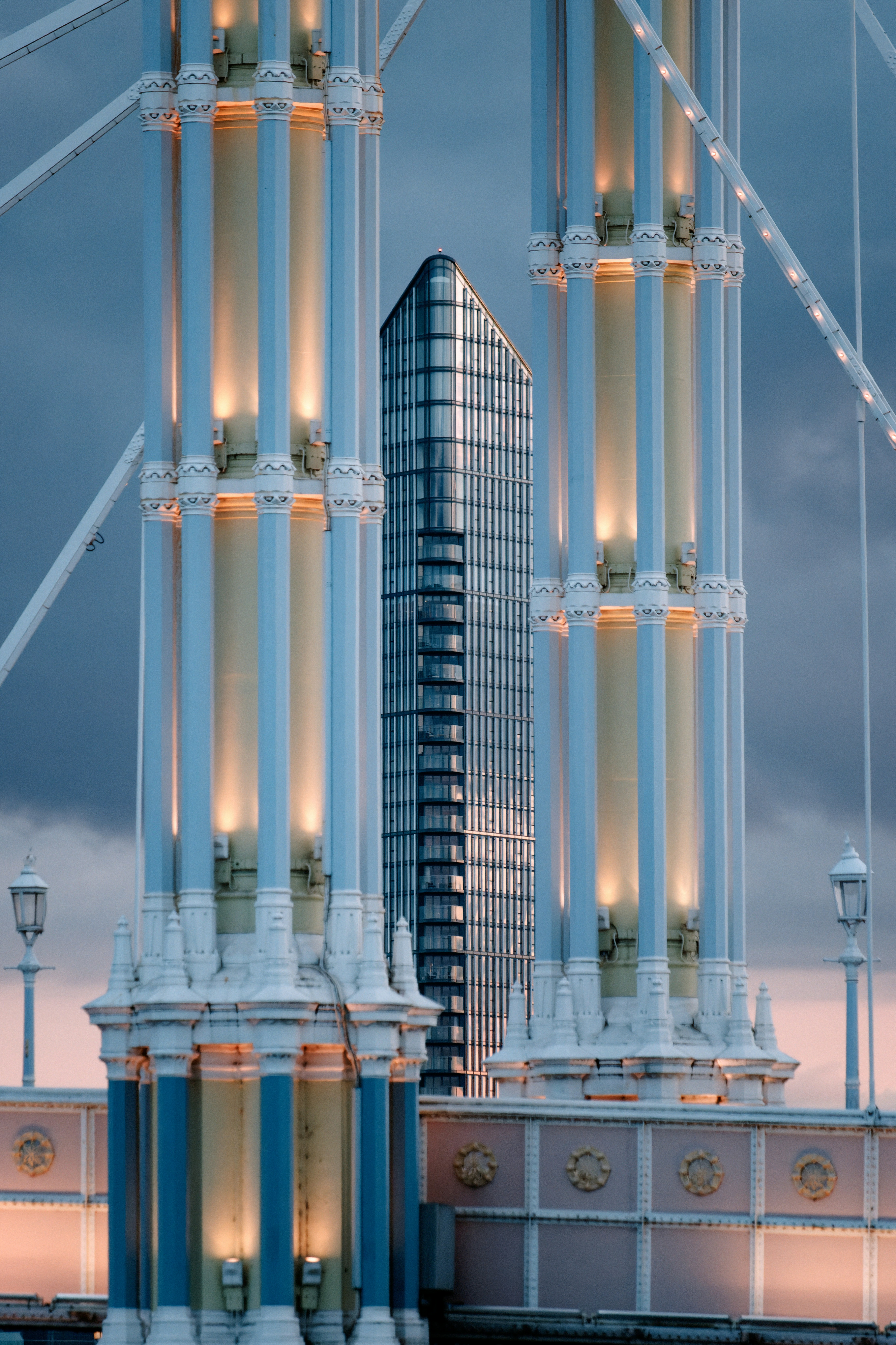 Towering Glass Through Ornate Ribs: A Skyline Framed by Neon Pillars
