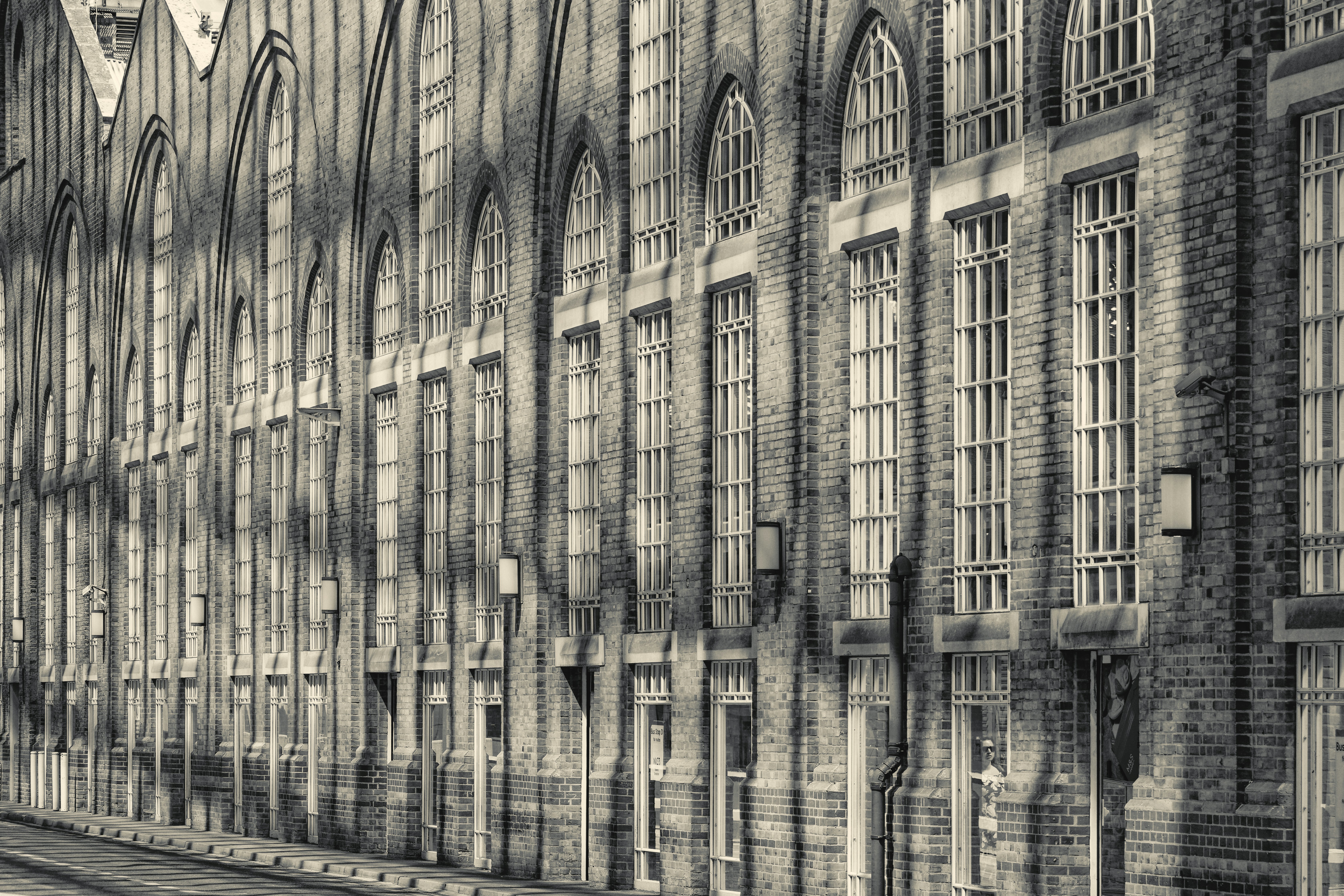 Brickwork Lines: A Repeating Archway Facade in Monochrome