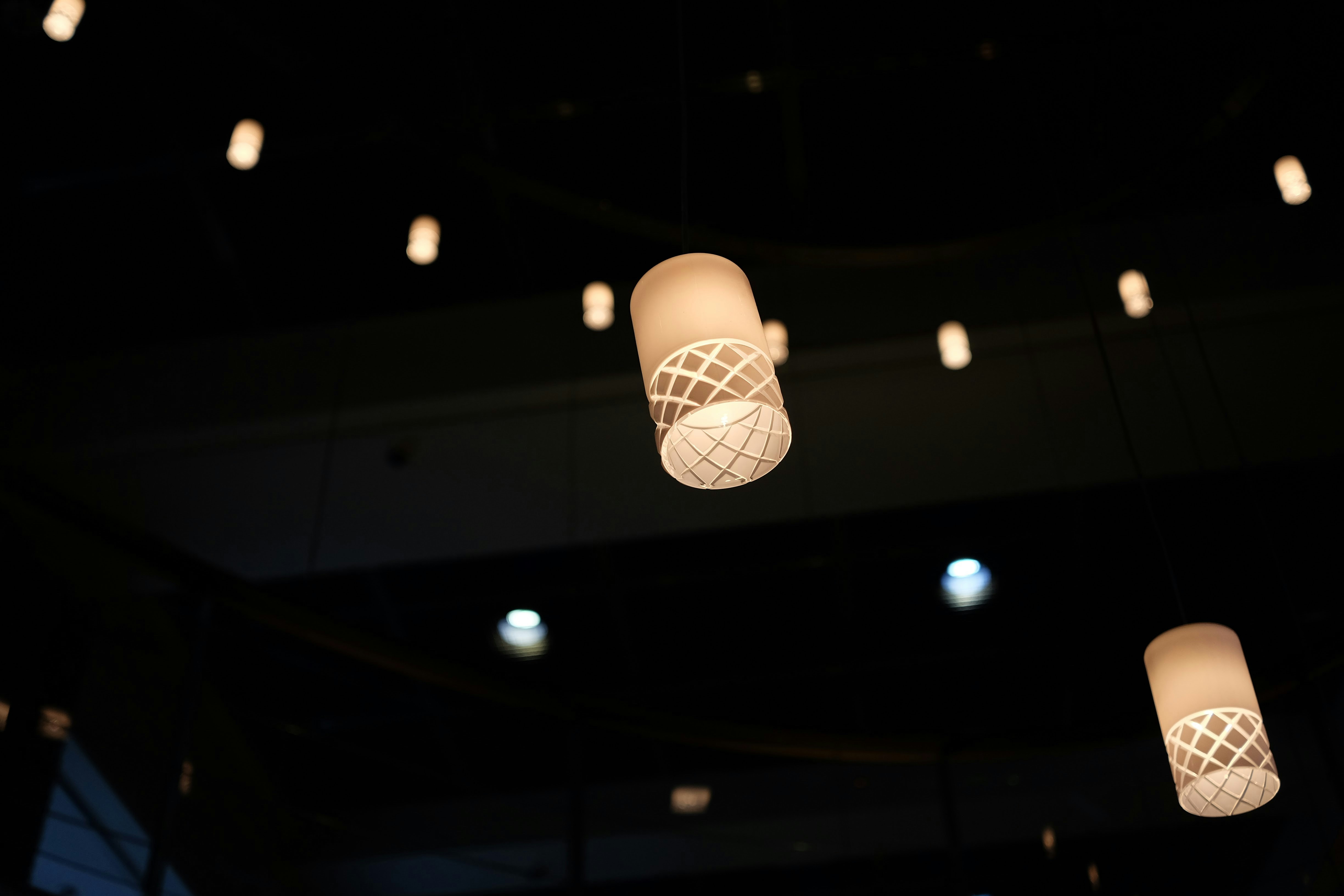 Floating Amber Luminaires in a Dim Studio