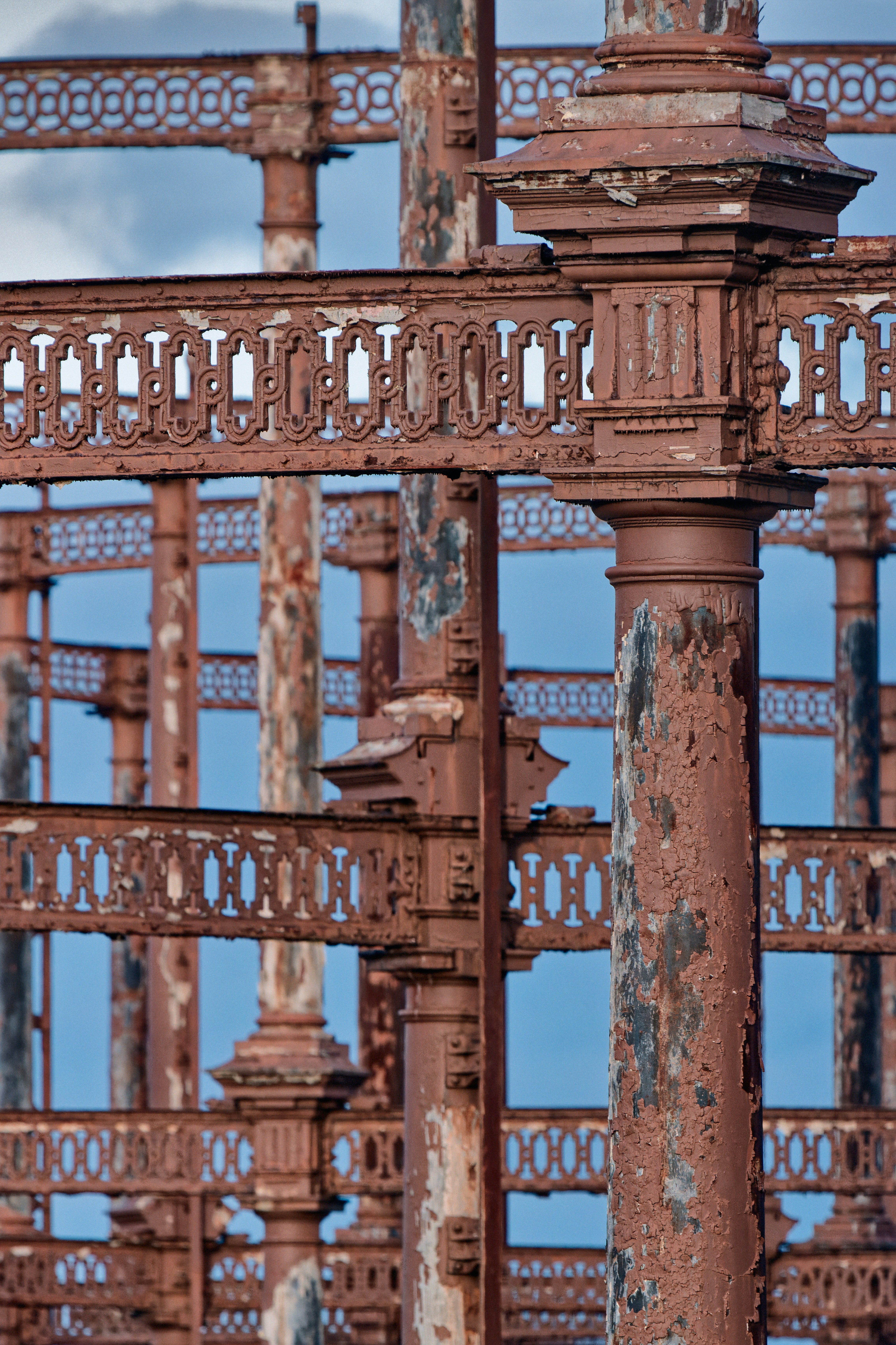 Rust and Lattice: Weathered Ironwork against a Clear Sky