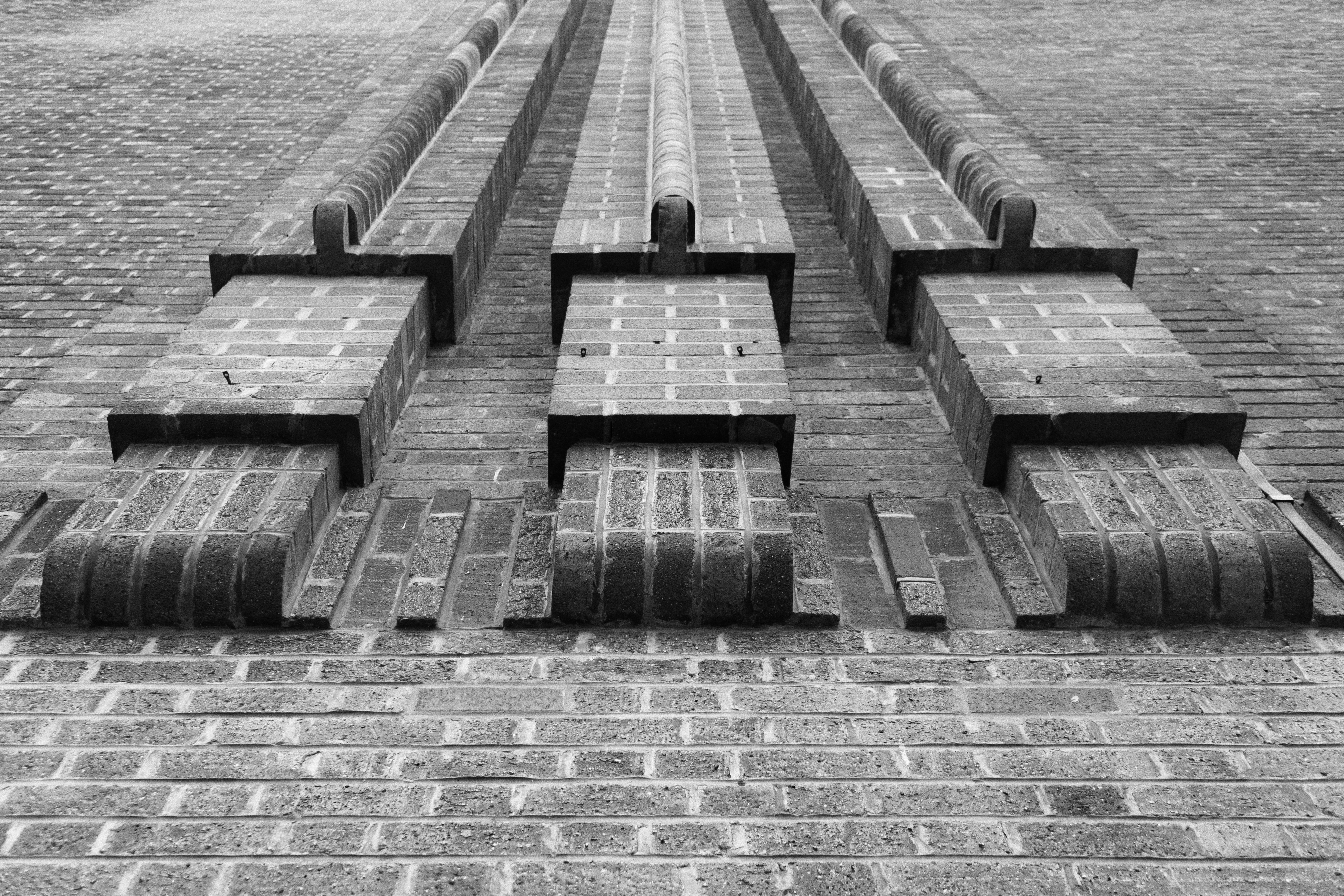 Symmetrical Brickwork and Metallic Lattice: A Railyard of Quiet Repetition