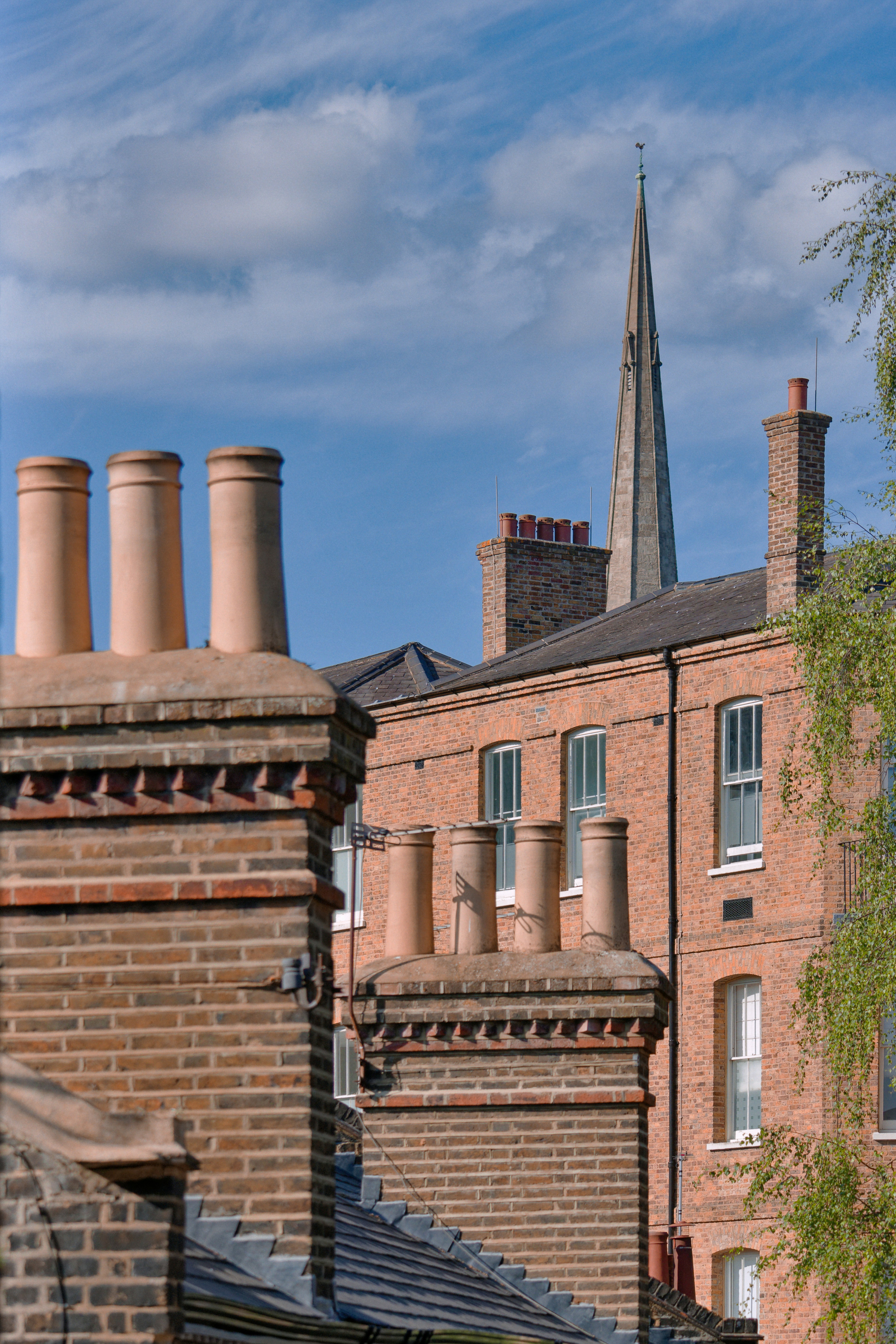Chimney Line and Spire Over a Brick Townscape