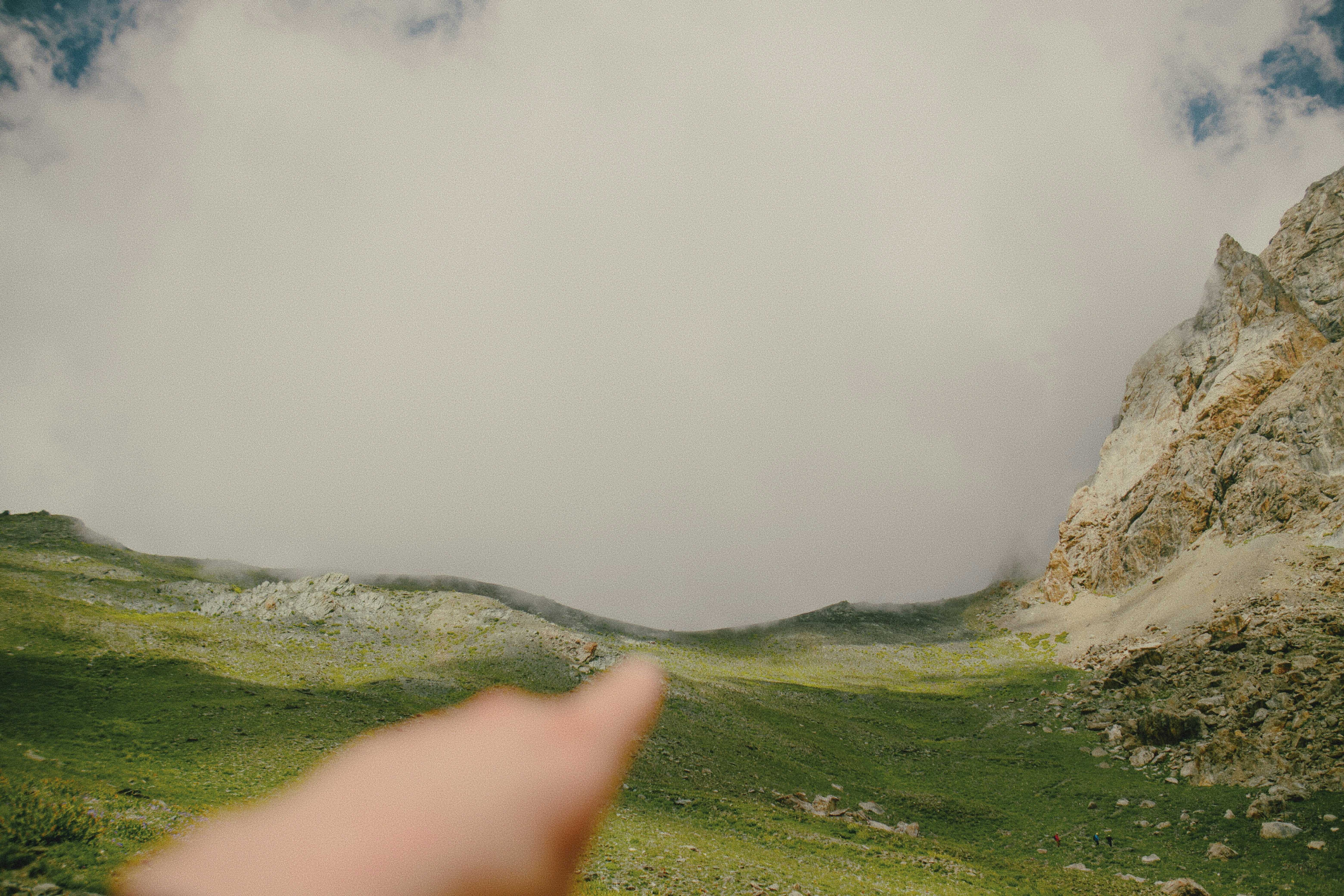 Foreground Blur Conveys Vast Alpine Basin Beyond a Misty Rim