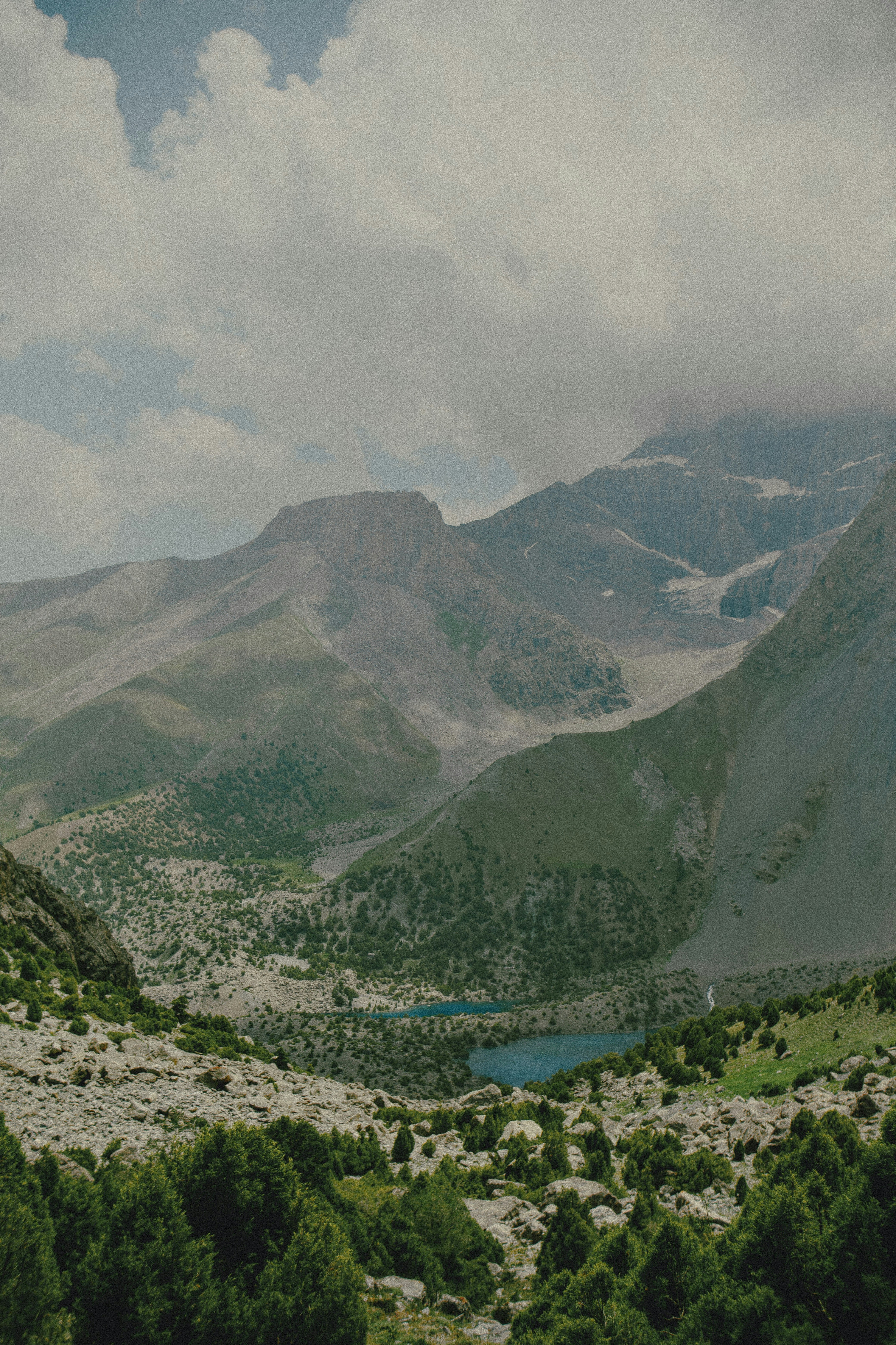 Valley Mirror: Alpine Lake Nestled Between Rugged Peaks