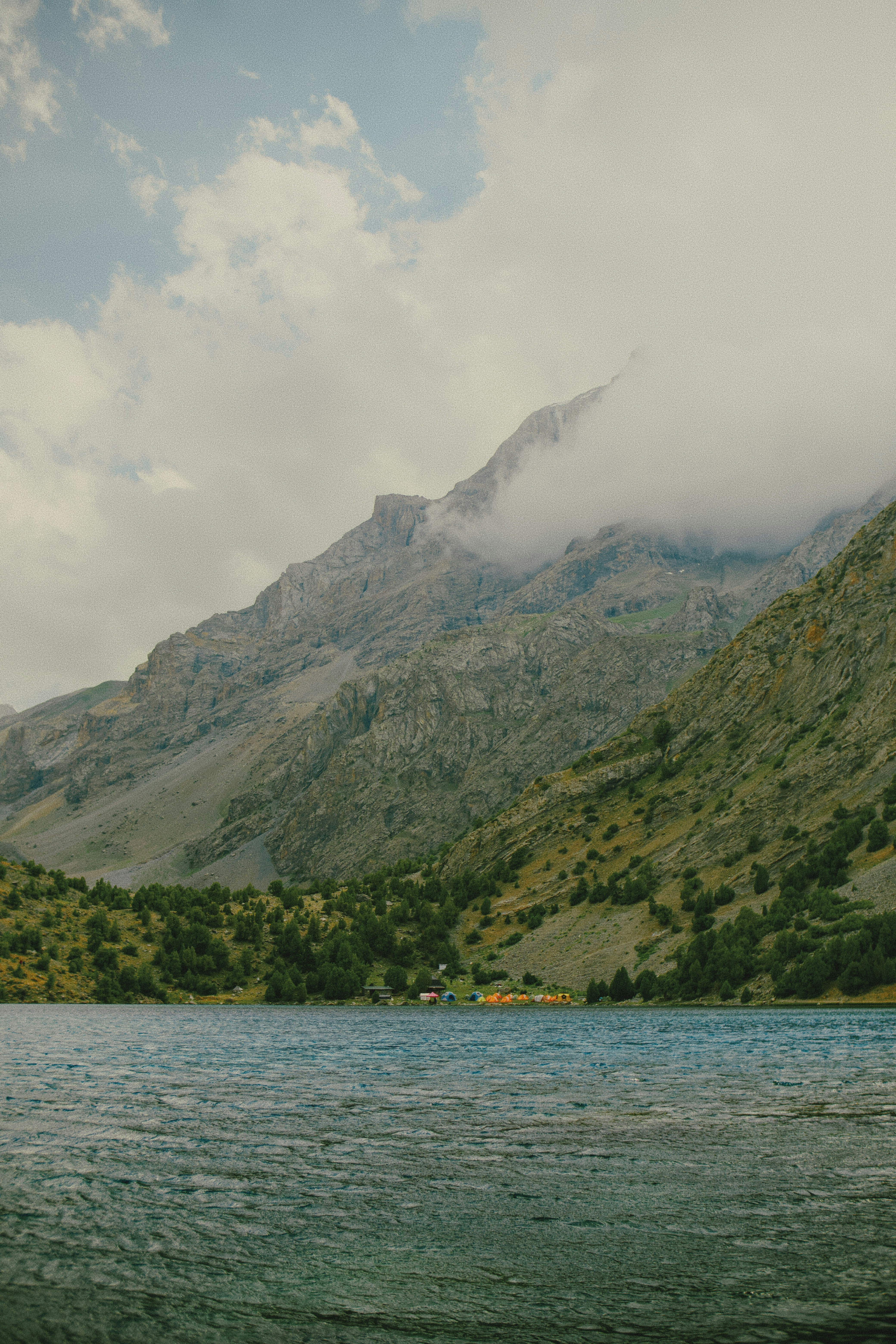 Lakeside Ridge Under a Cloud-veiled Peak