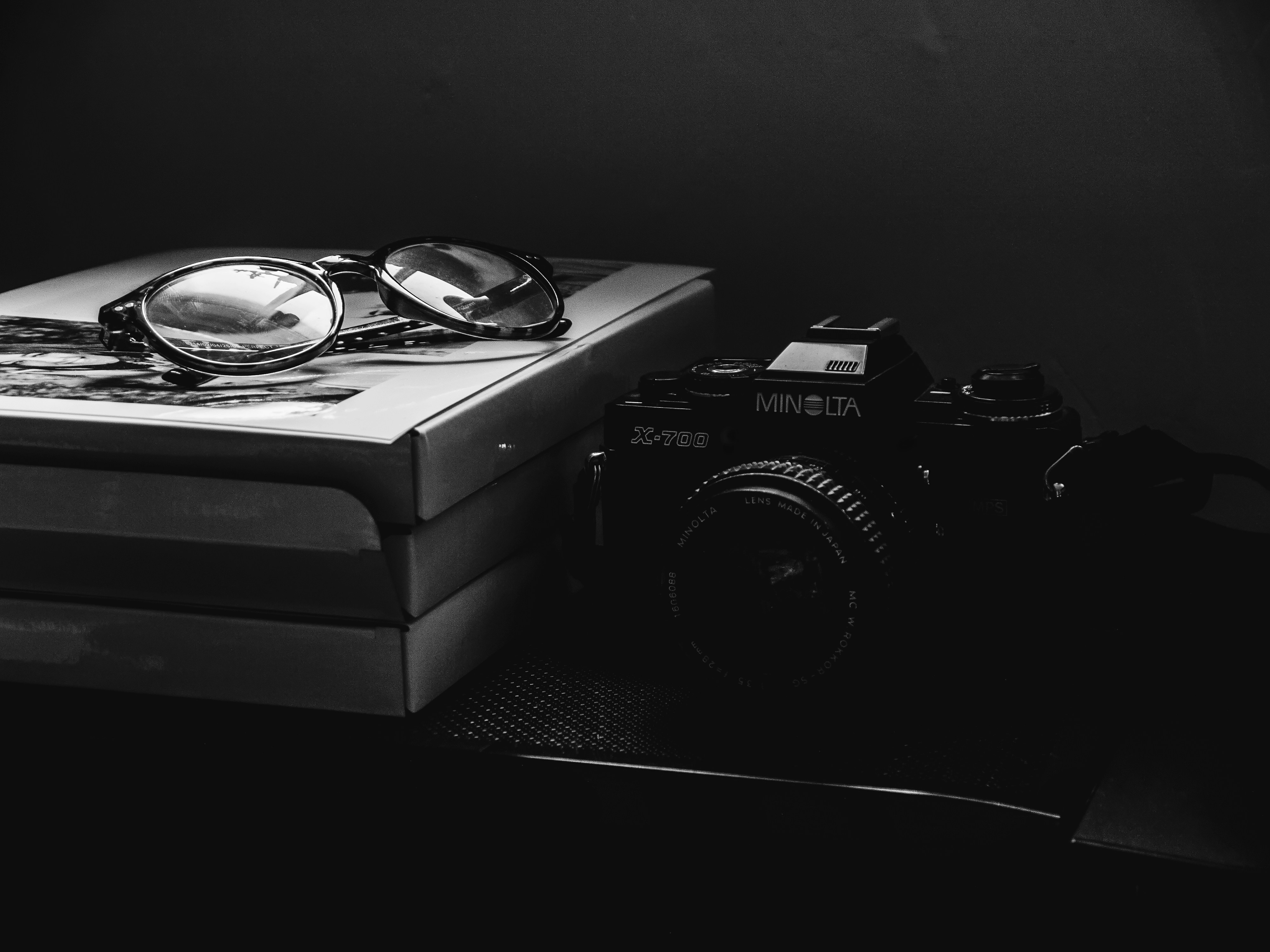 Glasses, Books, and a Classic Rangefinder: A Quiet Desk Portrait