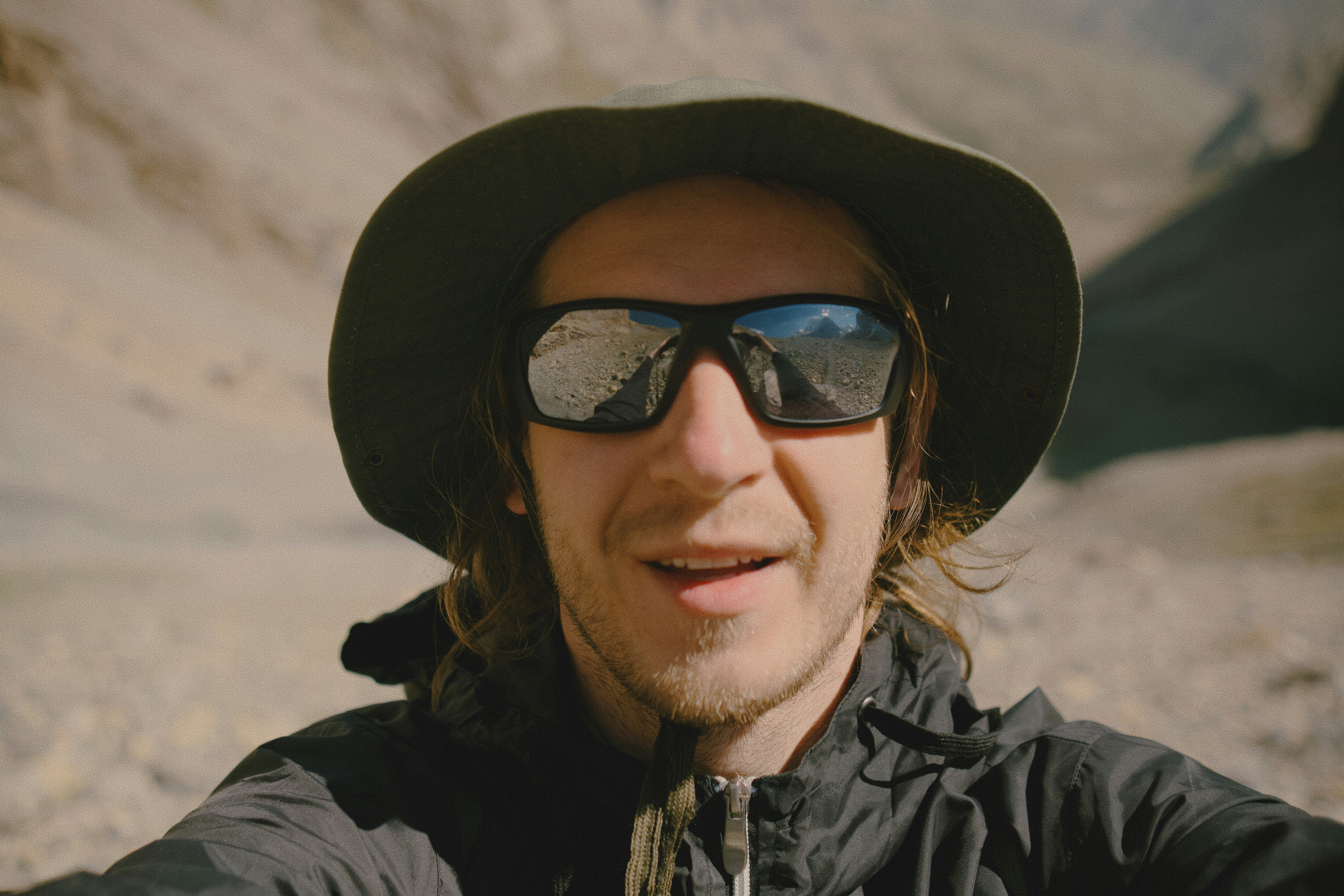 Desert Sunward: A Bearded Hiker in Wide Glasses