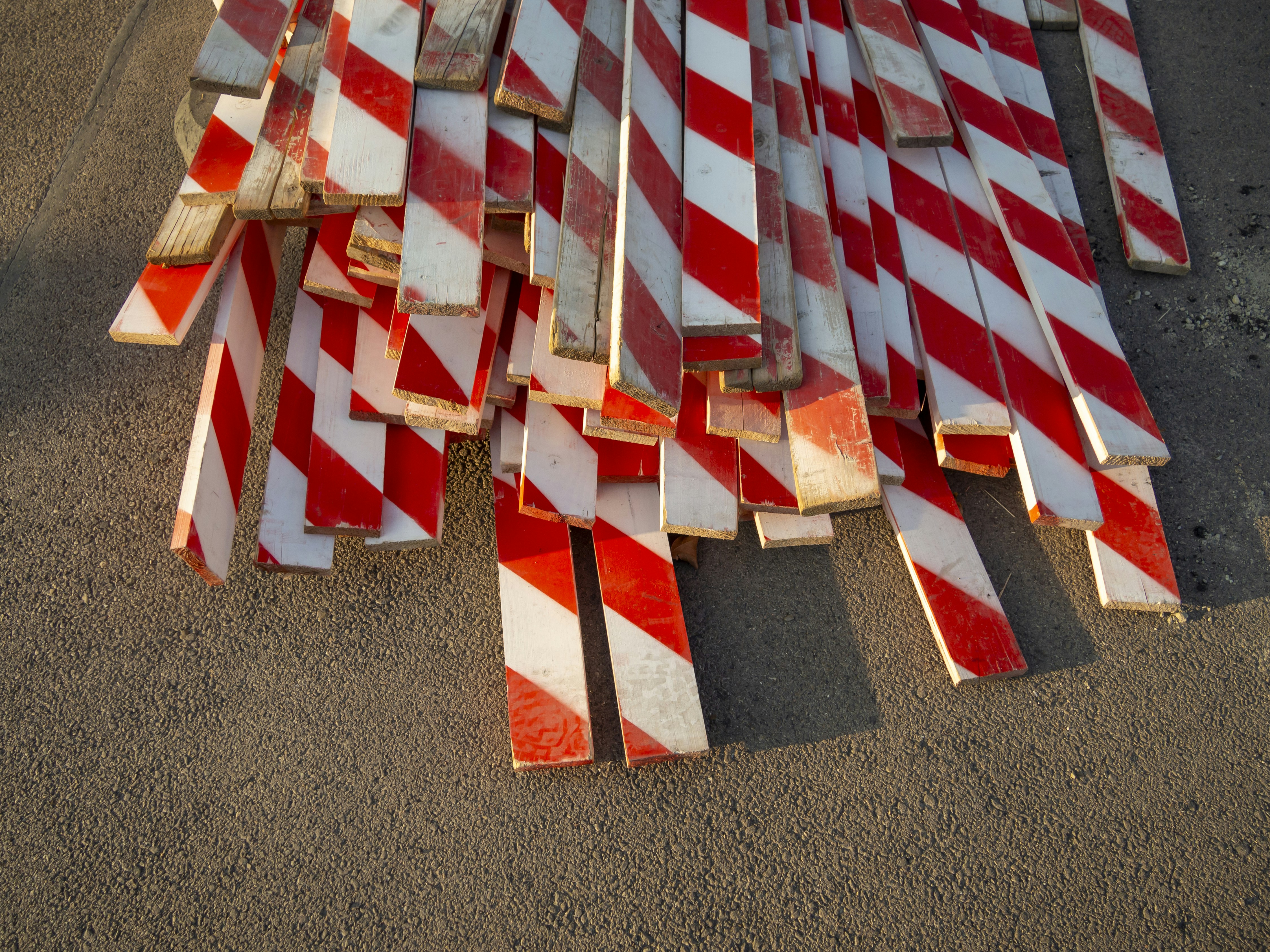 Red-and-White Hazard Stripes Piled on Asphalt