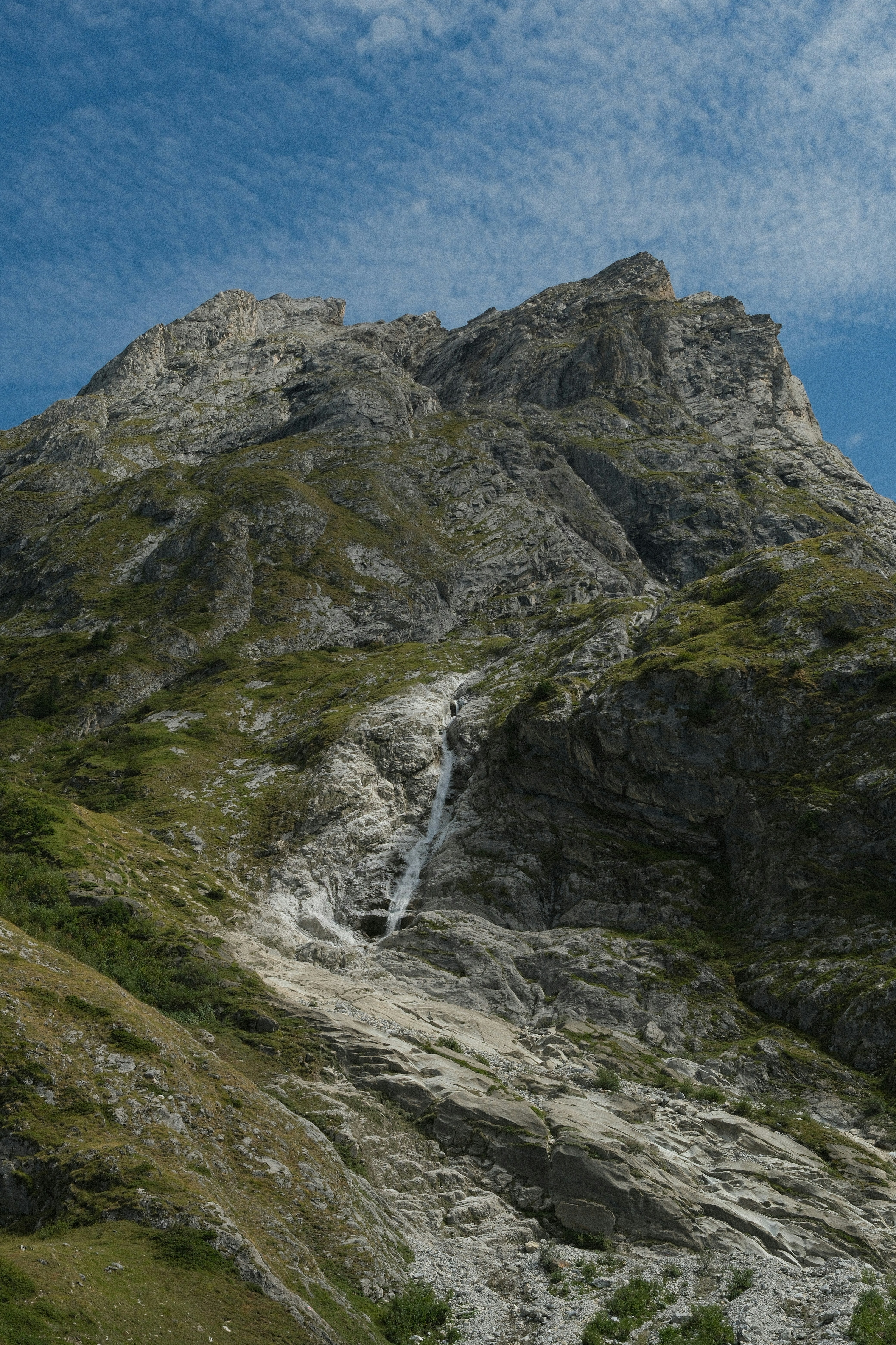Stone Spine and Silent Cascade on a Mountain Face
