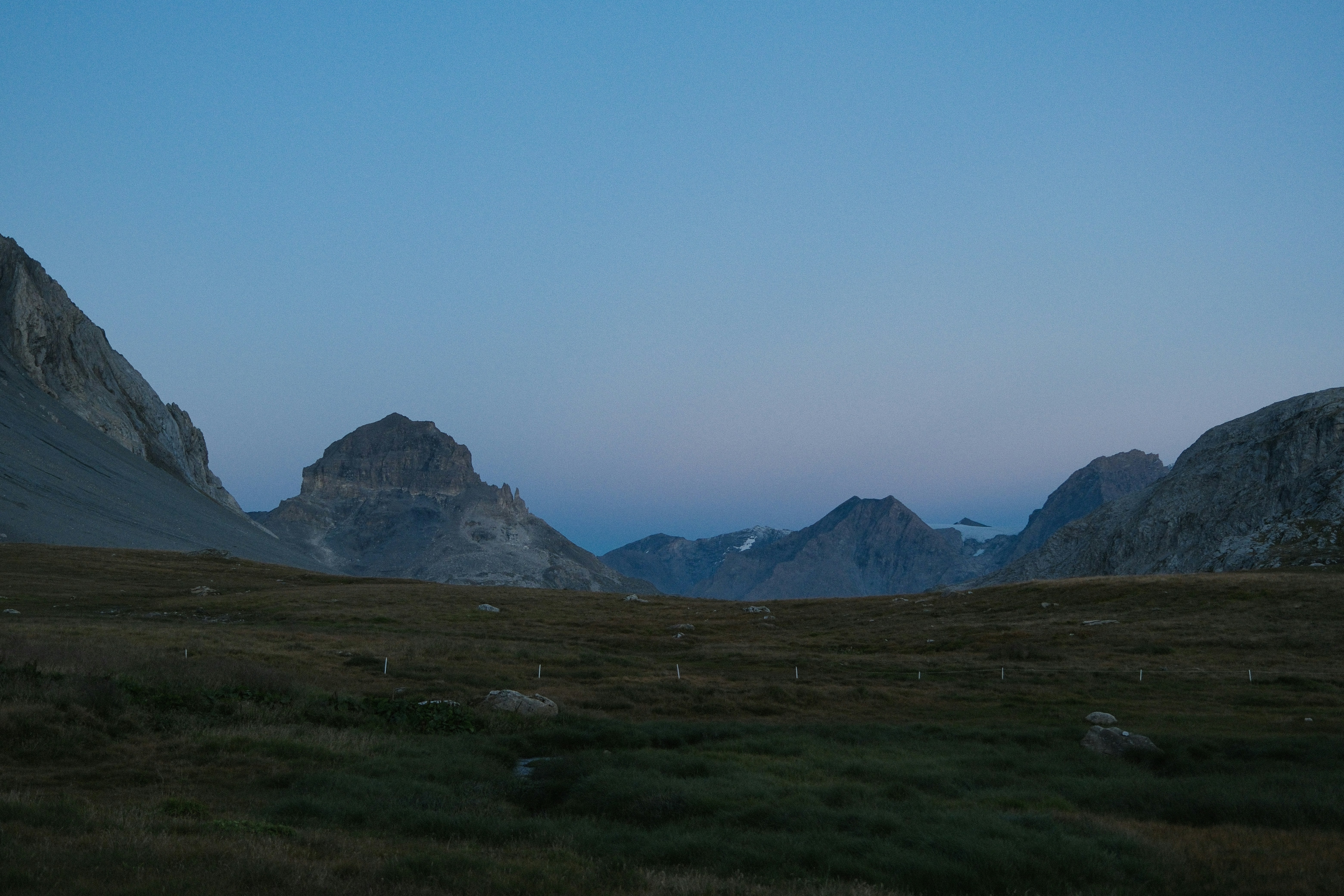 Quiet Basin Between Rugged Peaks at Dusk