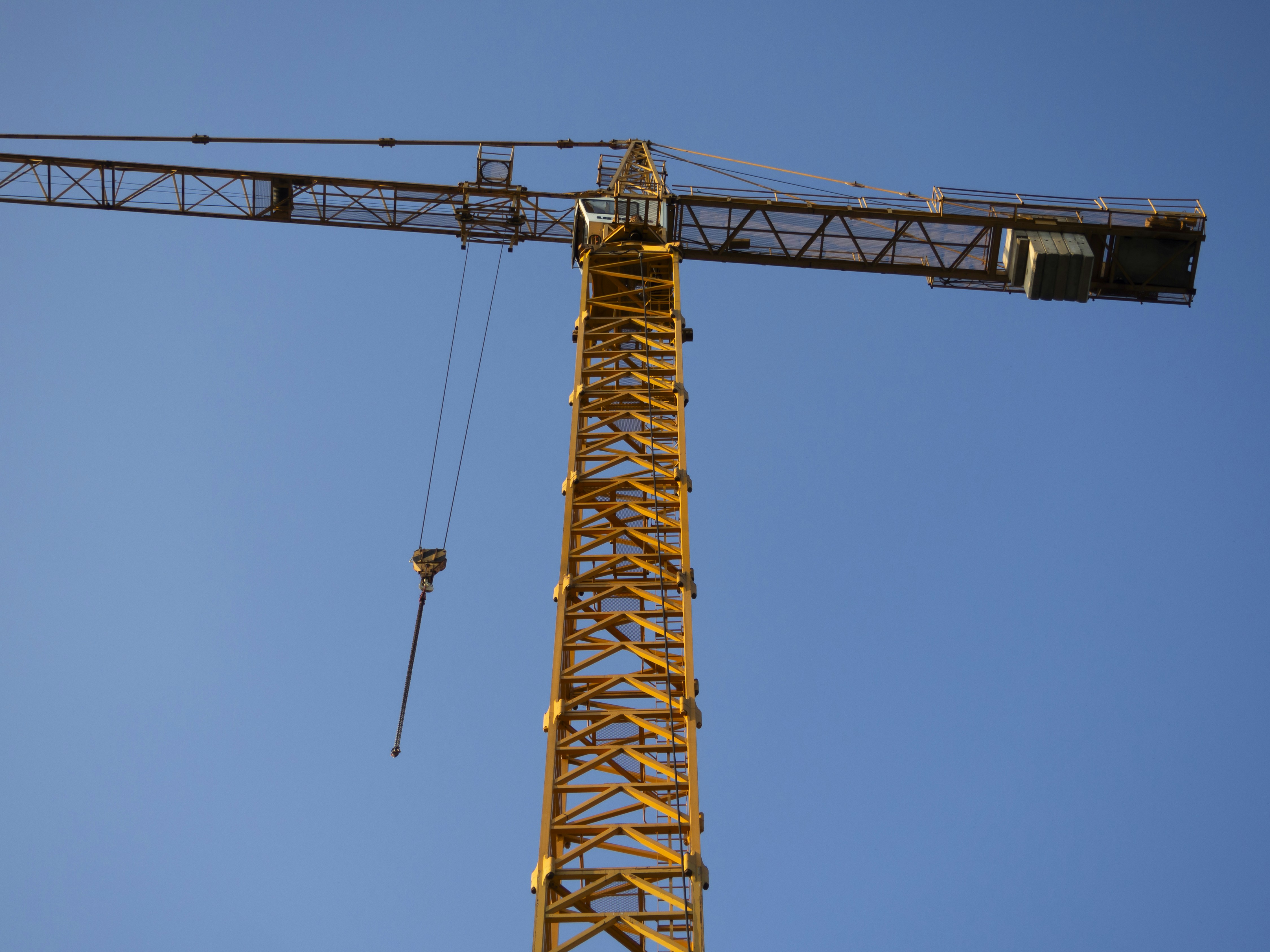 Tower Crane Reaching Toward a Clear Blue Sky