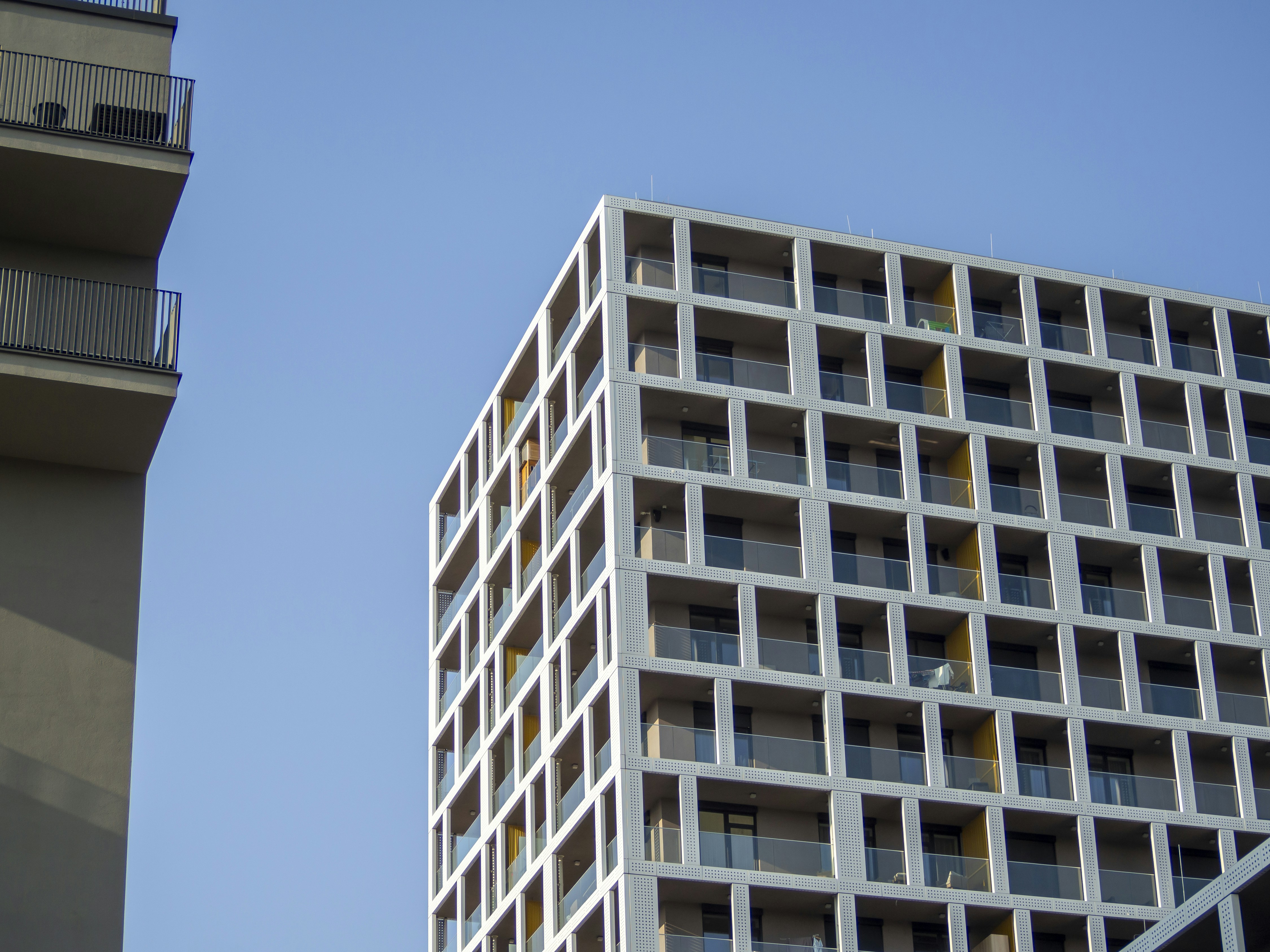 Concrete Lattice: A Urban Facade in Strong Blue Sky