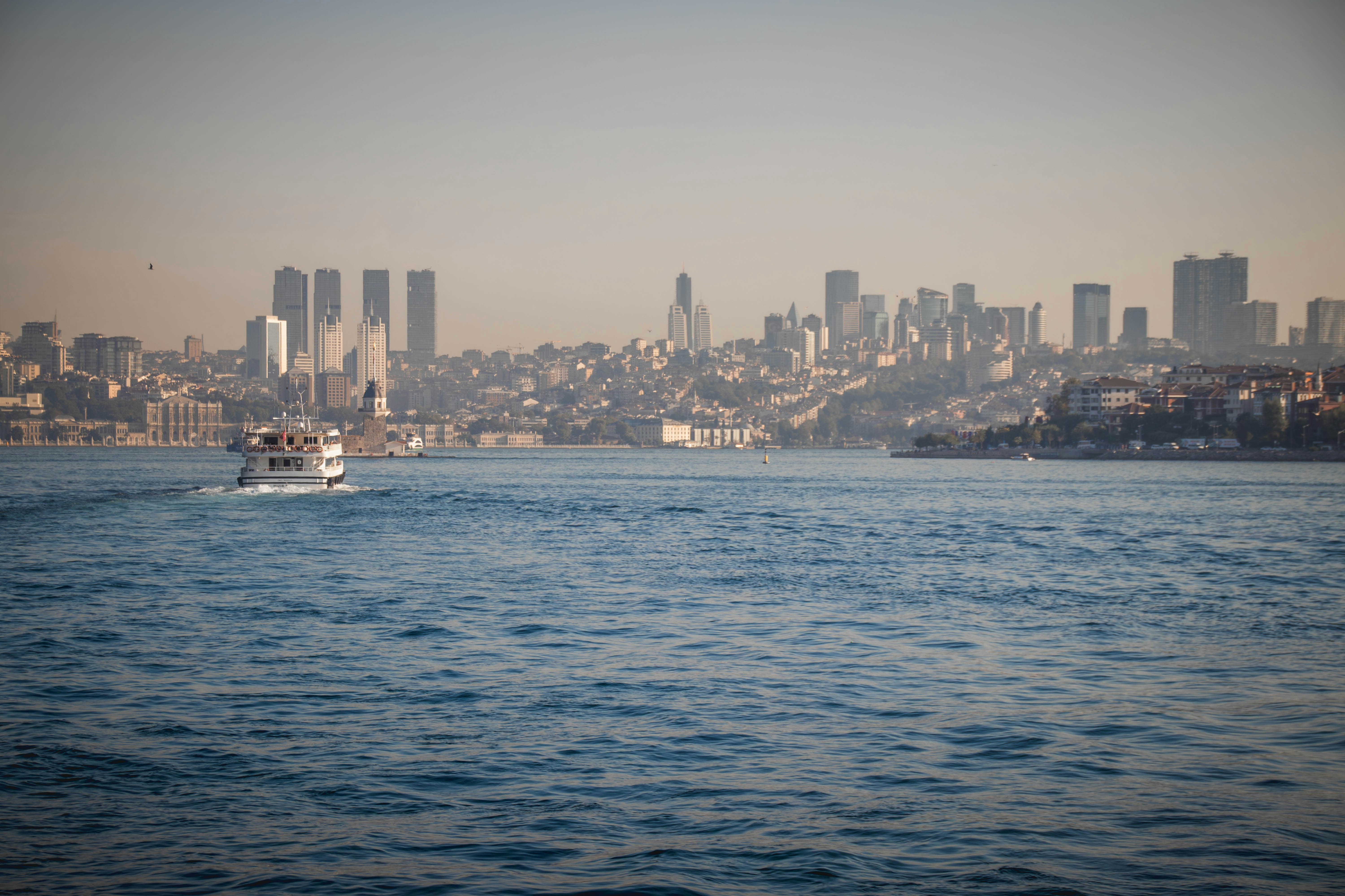 Harbor at Dusk: Boat on Quiet Waters with a City Silhouette