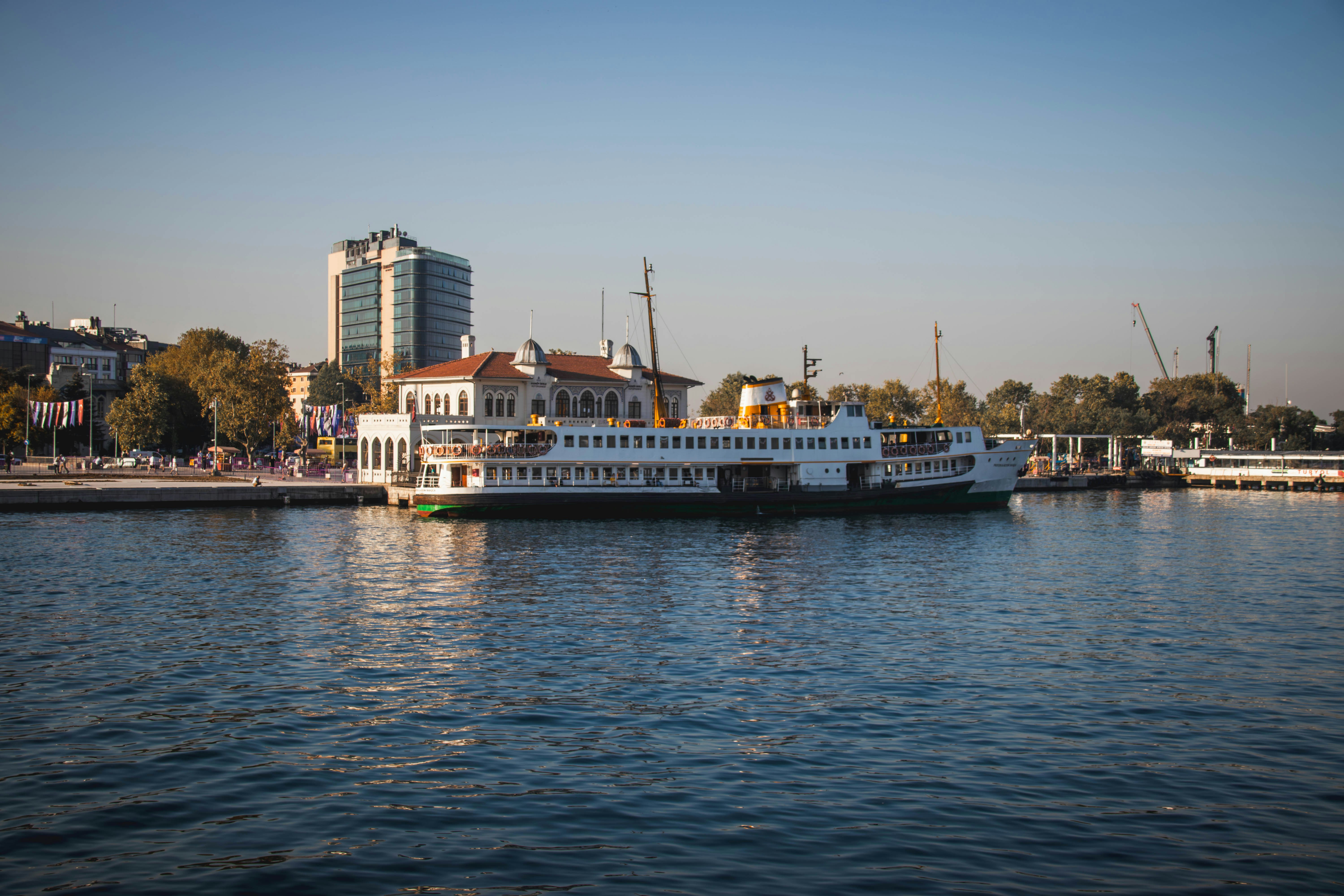 Harbor Vessel at Dusk: A Riverside Ferry Anchored by the City