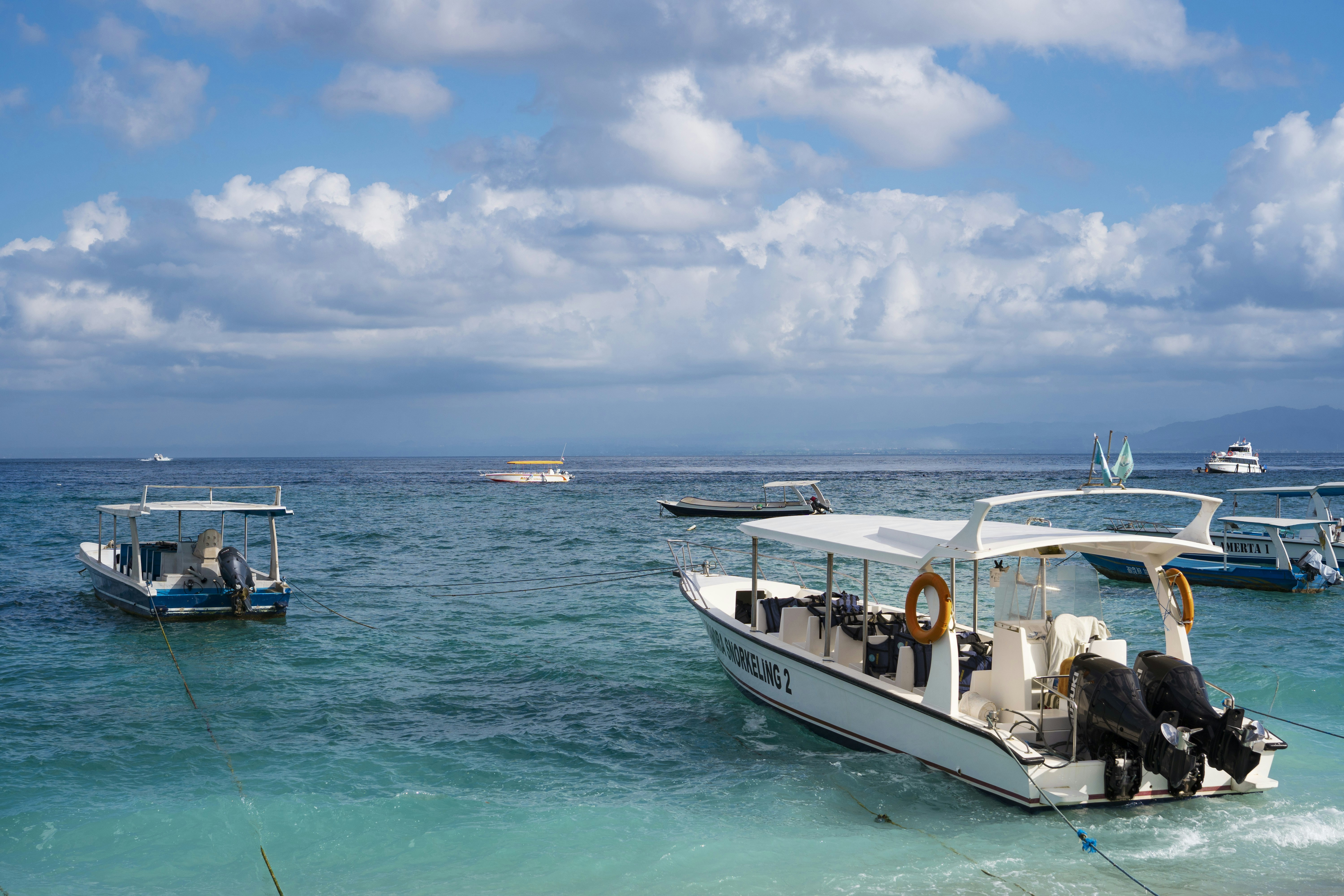 Turquoise Bay: Boats Rest at Shore Under Open Sky