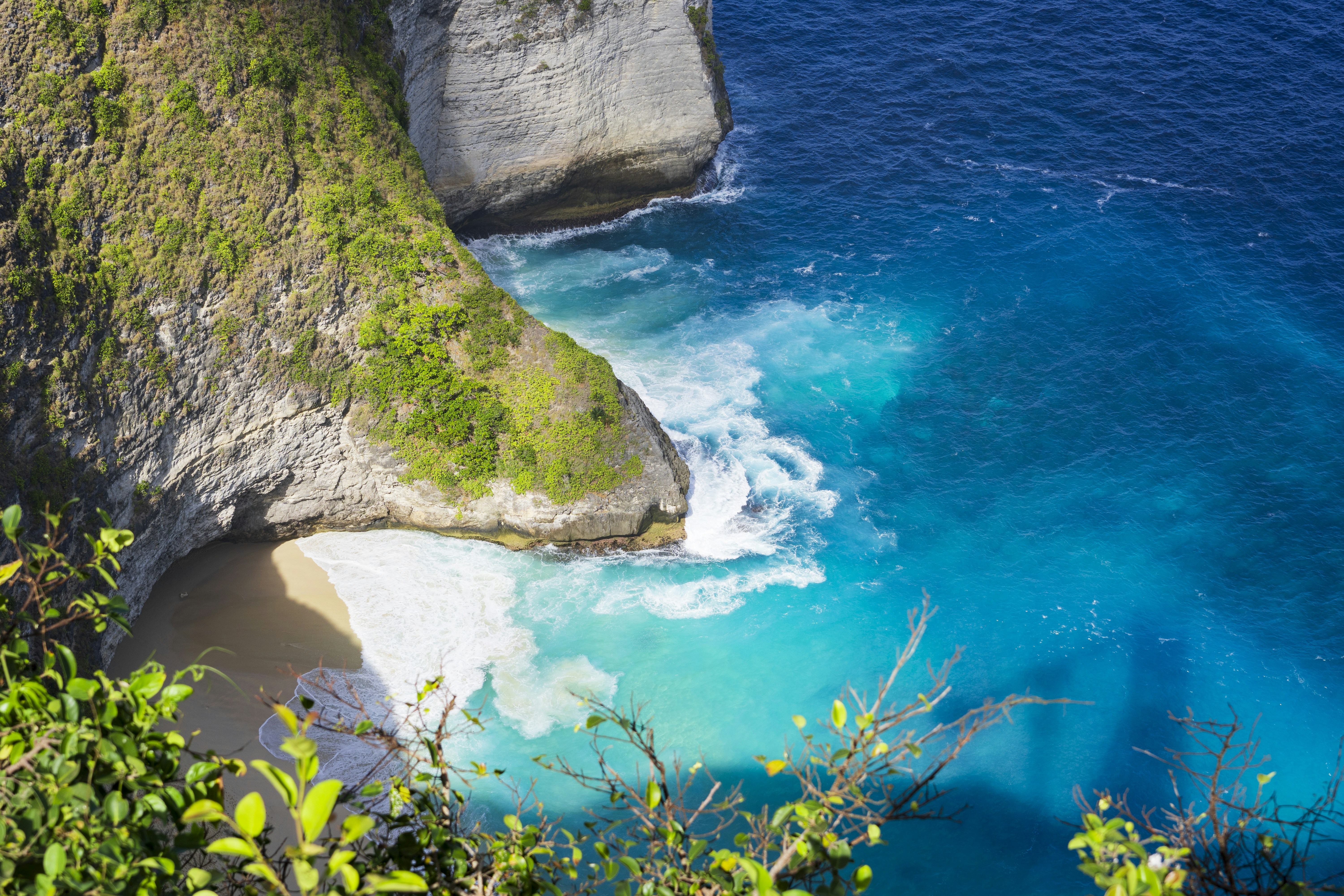 Emerald Cove: Cliffside Archway Framed by Turquoise Waves