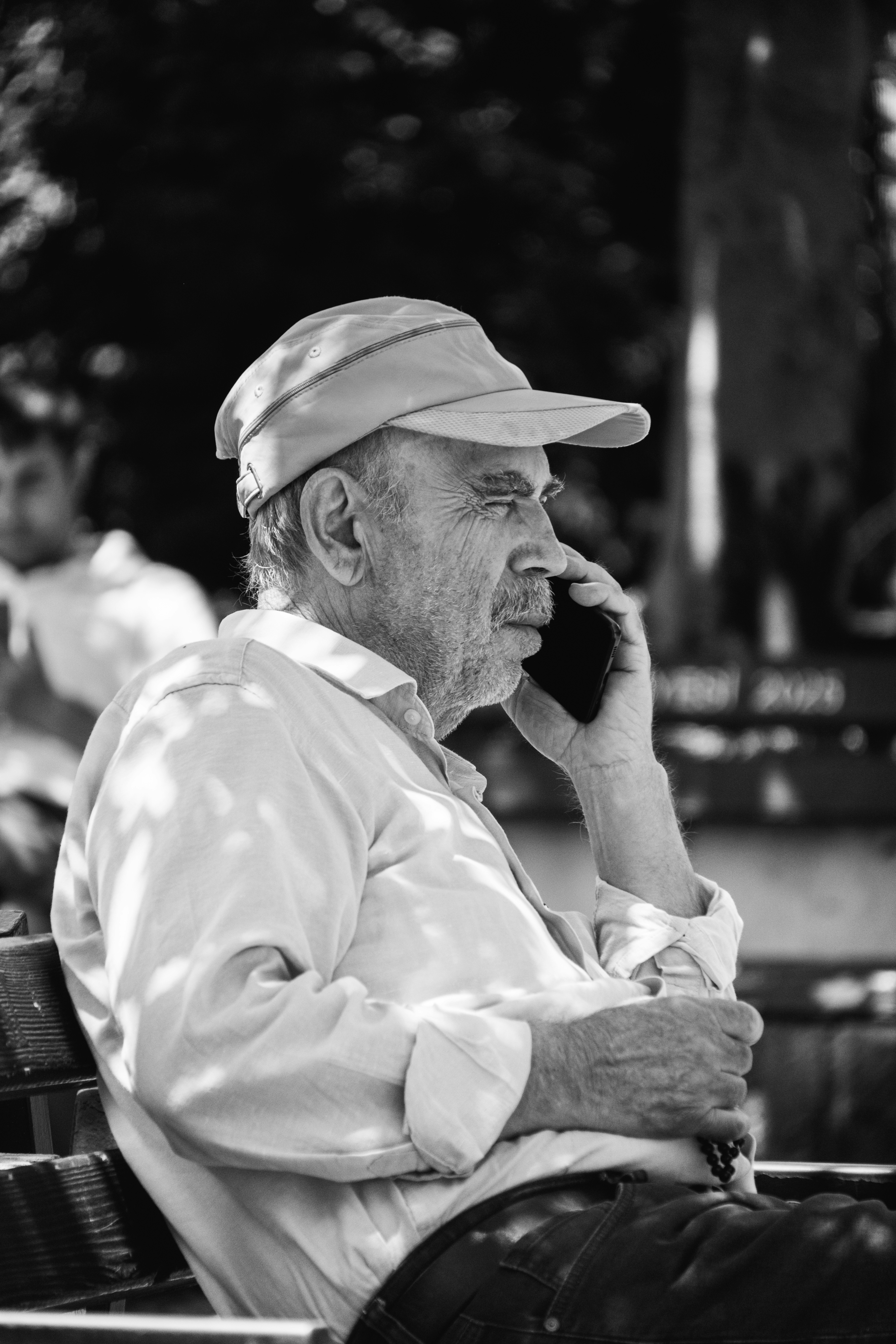 Old-Seat Conversation: A Man on a Phone in Quiet Light
