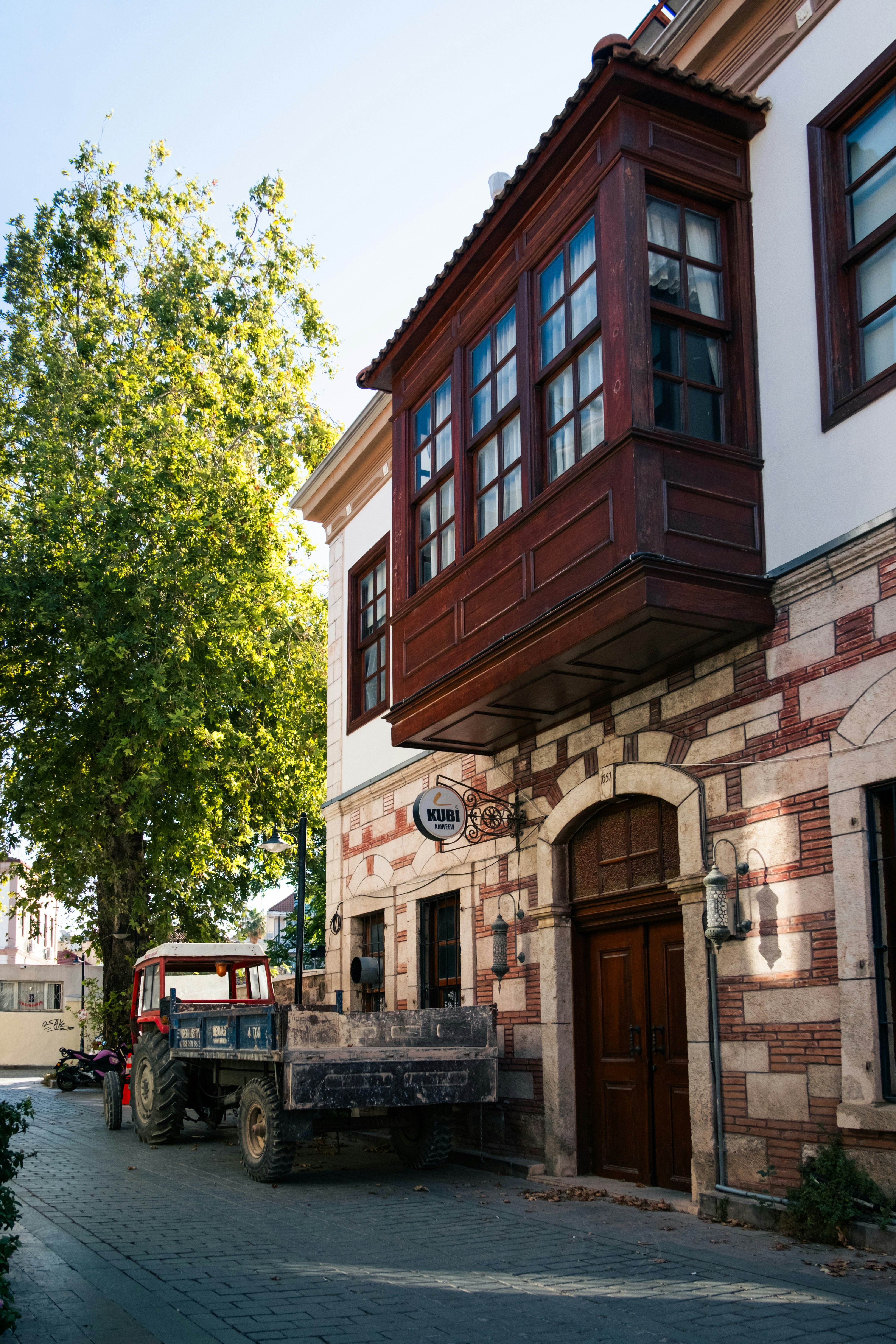 Red Brick Inn Overhang: A Corner Street with a Fruitful Balcony